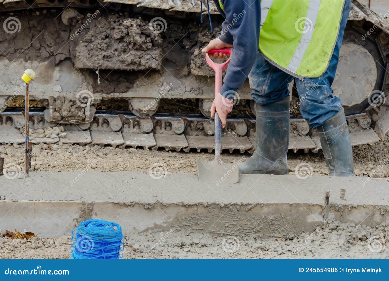 Groundworker Placing Wet Concrete Inside Formwork during Roadworks ...