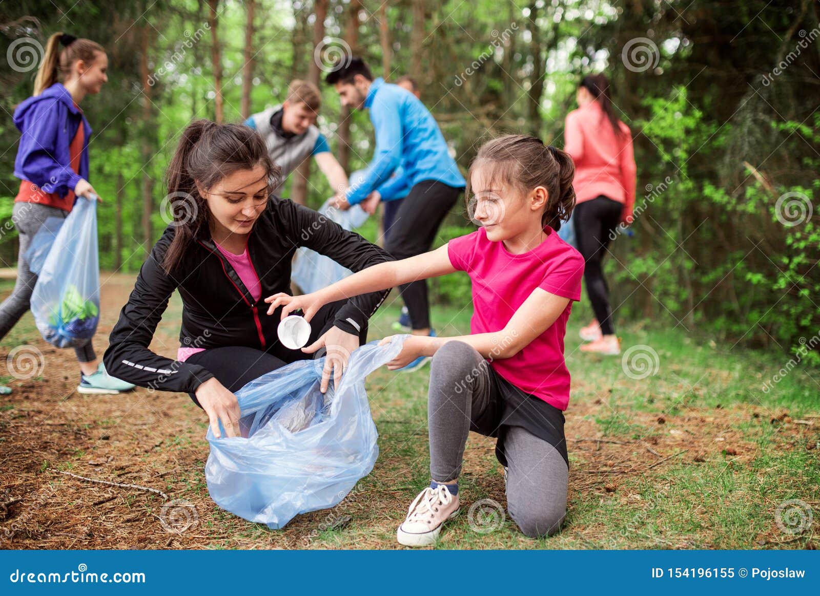 Group of Active People Picking Up Litter in Nature, a Plogging Concept ...