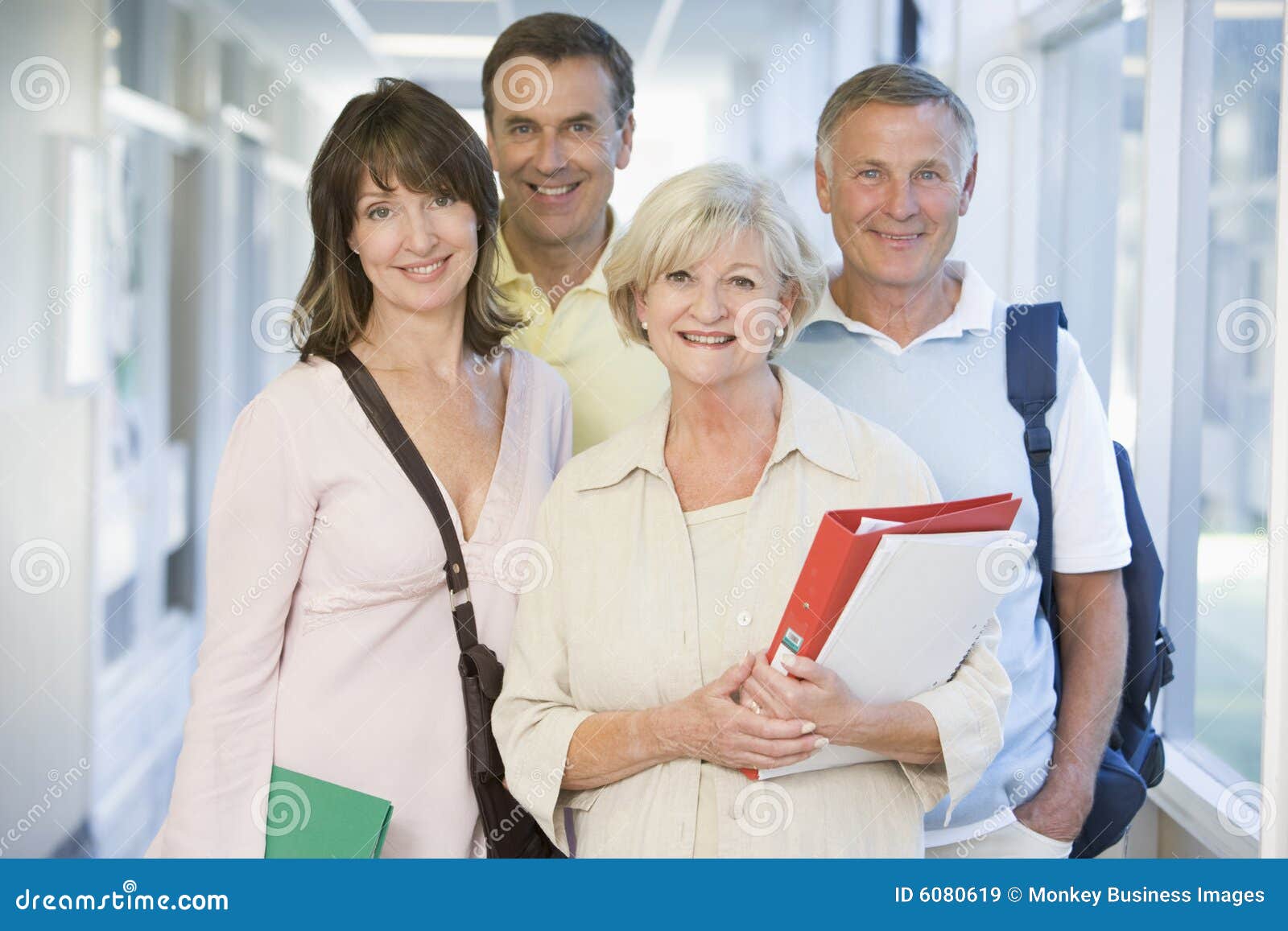 A Group Of Adult Students Standing In A Corridor Royalty-Free Stock ...