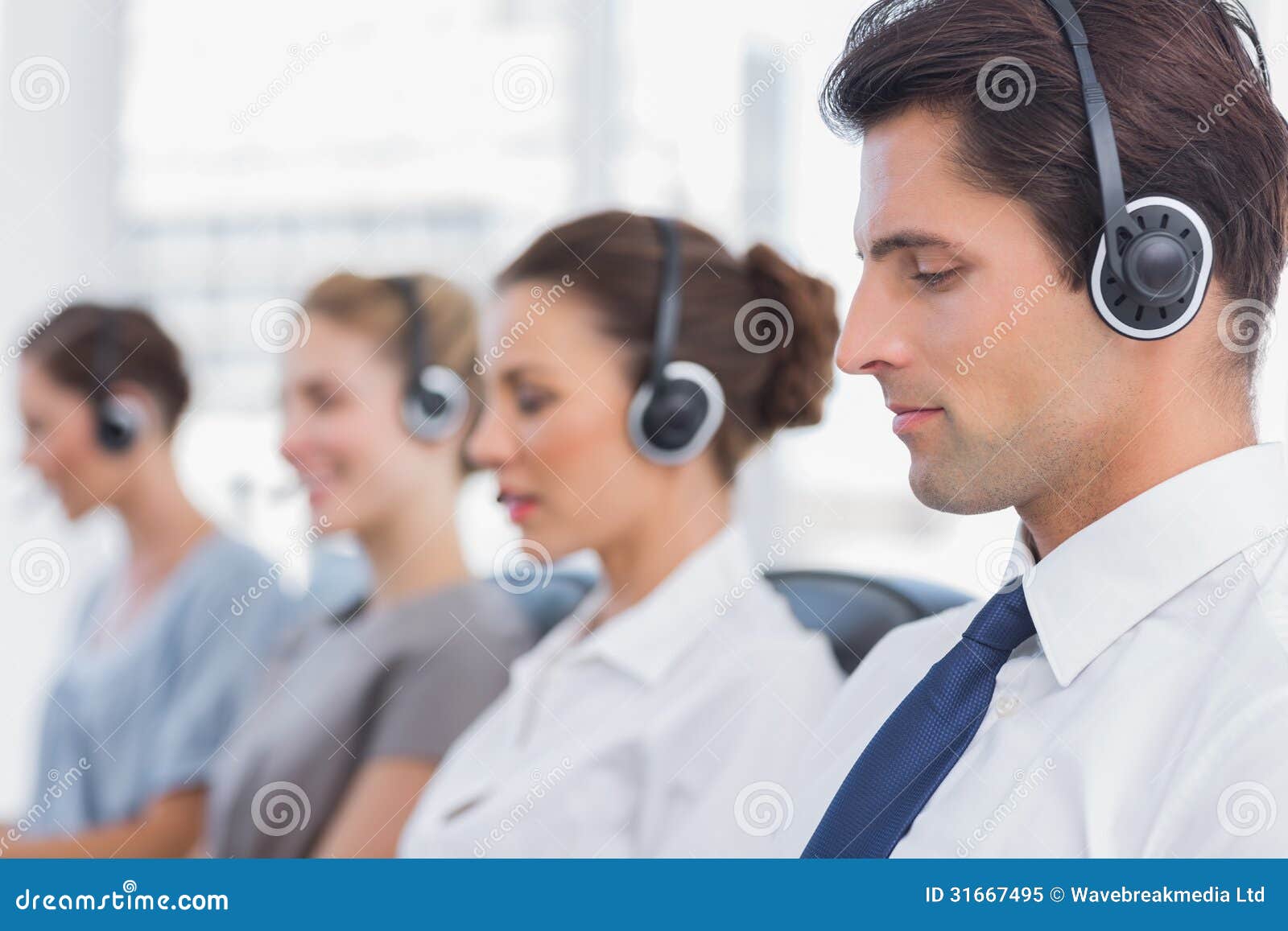 Group of Agents Sitting in Line in a Call Centre Stock Image - Image of ...
