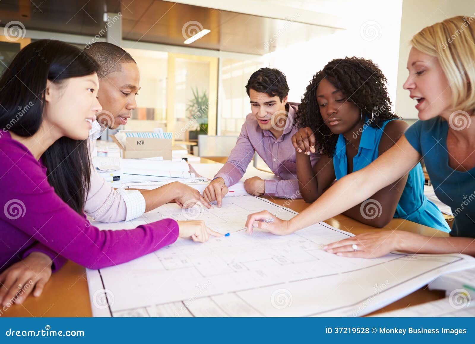 Group of Architects Discussing Plans in Modern Office Stock Photo ...