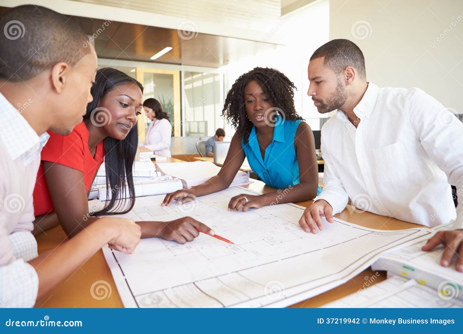 Group of Architects Discussing Plans in Modern Office Stock Photo ...