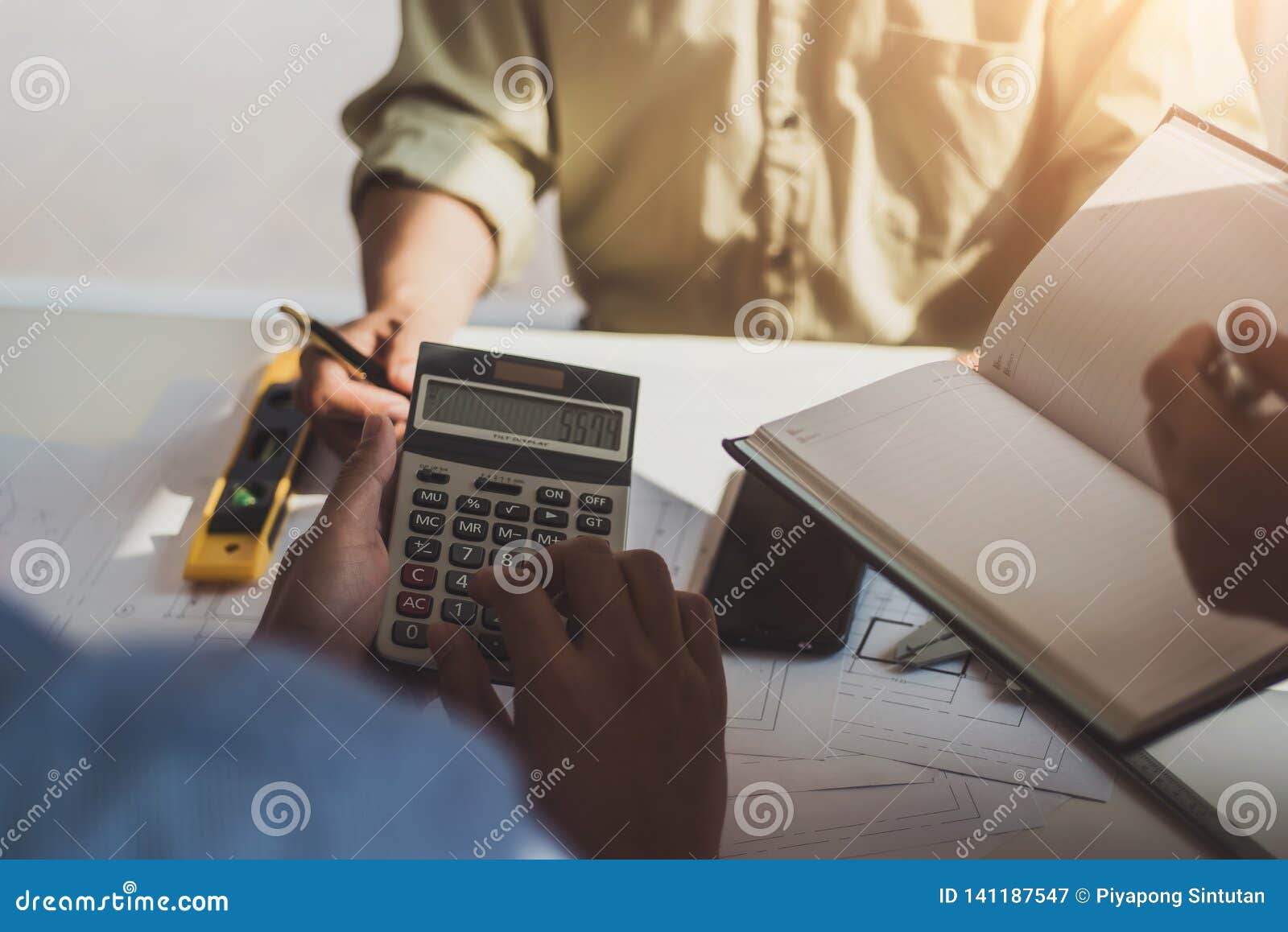 Group of Architects Discussing and Using Calculator about Calculate the ...