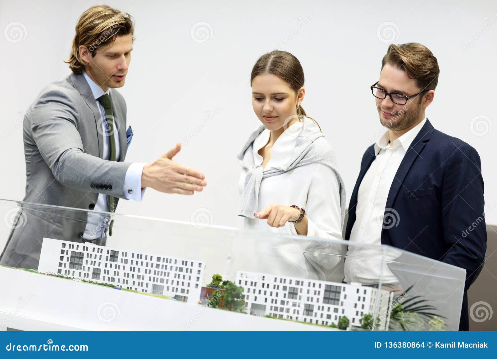 Group Of Architects Discussing With Blueprints Plans In Office Design ...