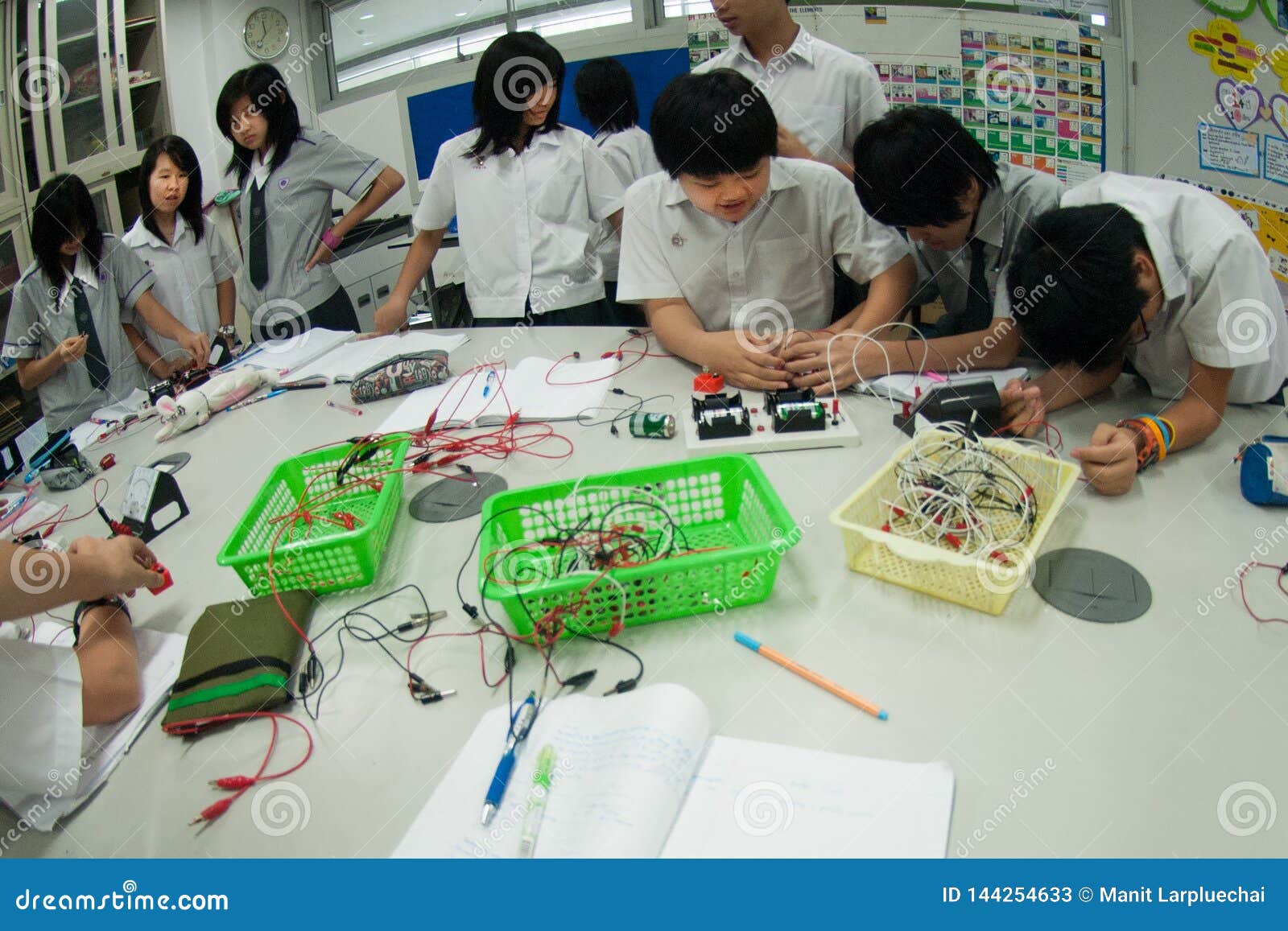 Group of Asian Elementary Students are Learning about Electricity in ...