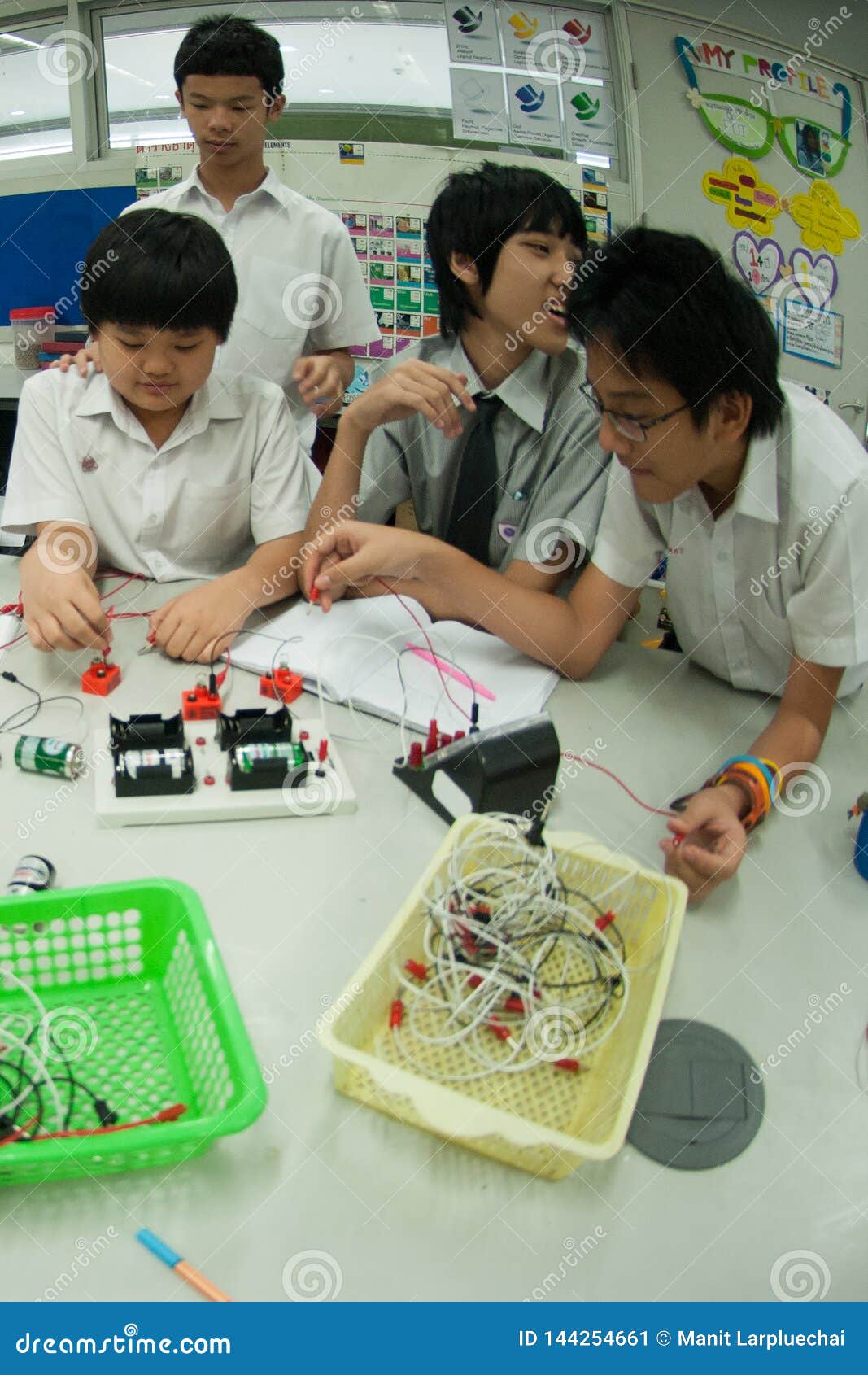 Group of Asian Elementary Students are Learning about Electricity in ...