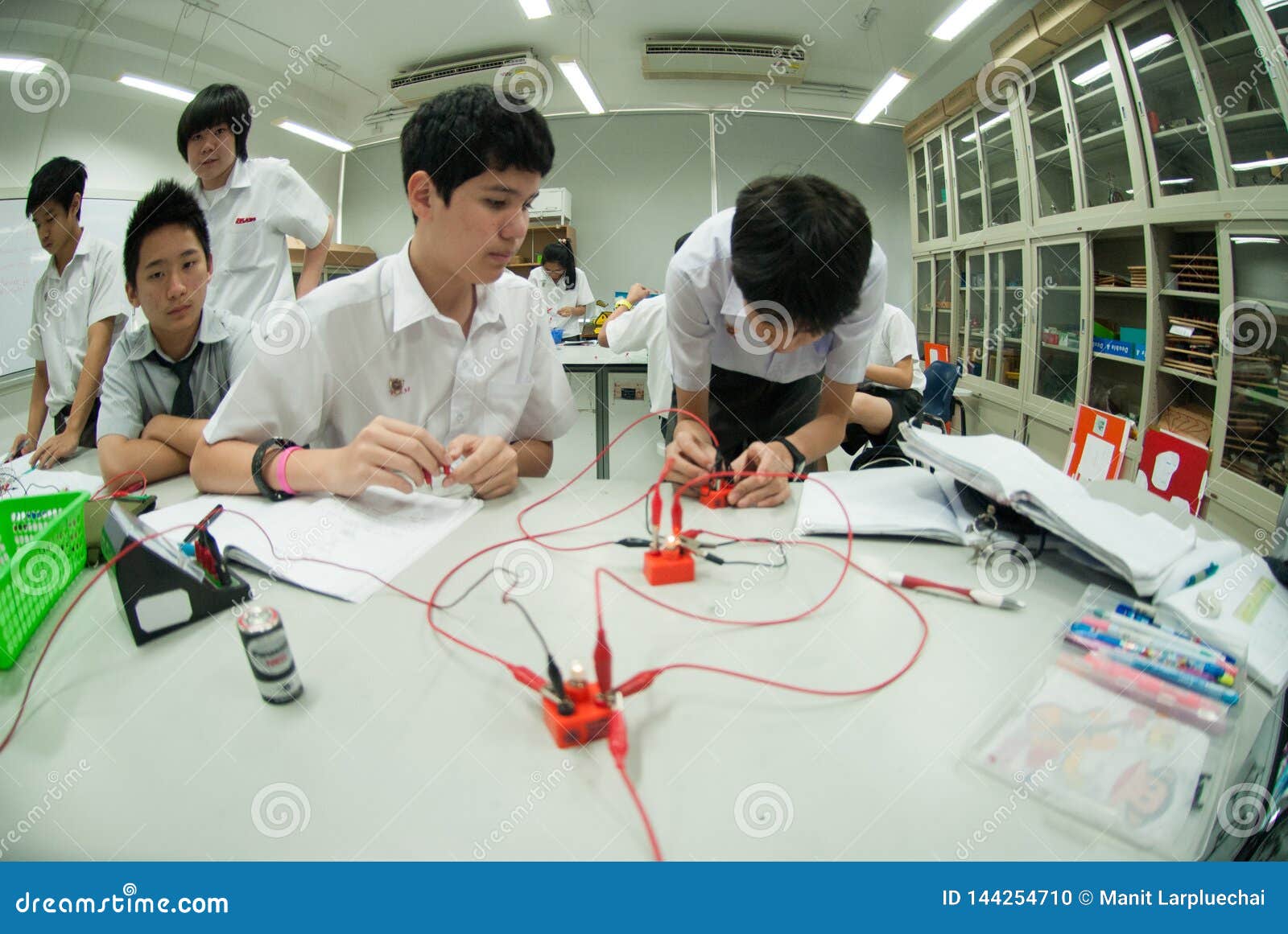 Group of Asian Elementary Students are Learning about Electricity in ...
