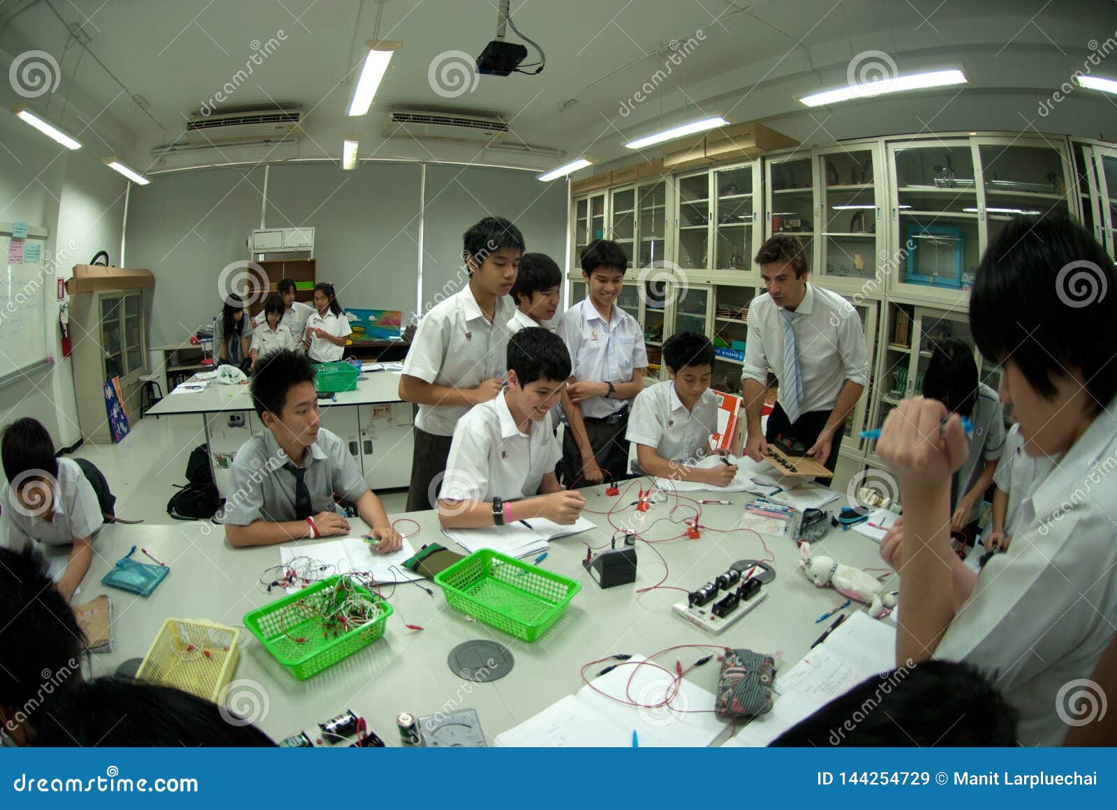 Group of Asian Elementary Students are Learning about Electricity in ...