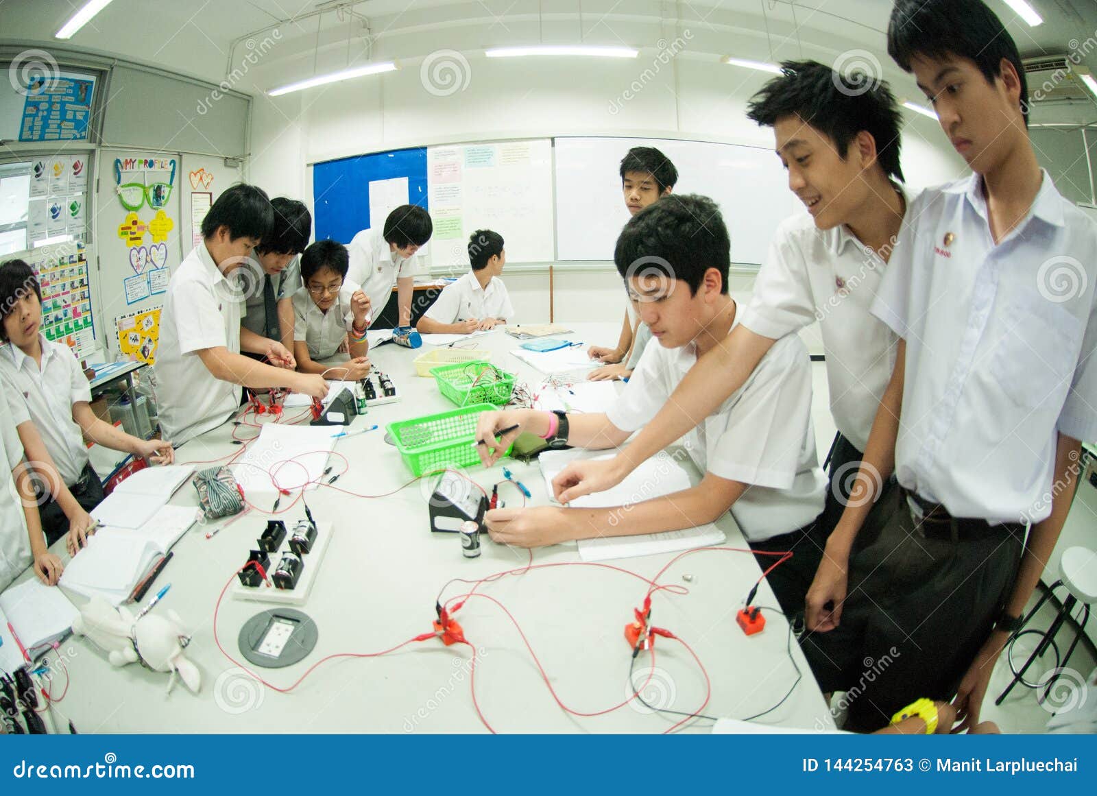Group of Asian Elementary Students are Learning about Electricity in ...