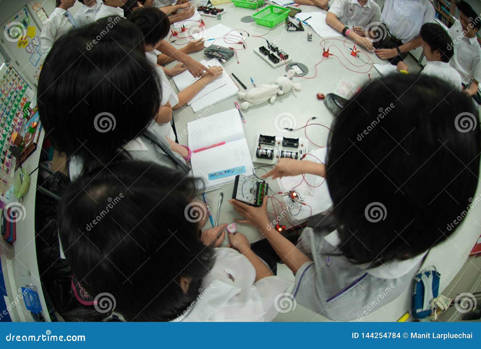 Group of Asian Elementary Students are Learning about Electricity in ...