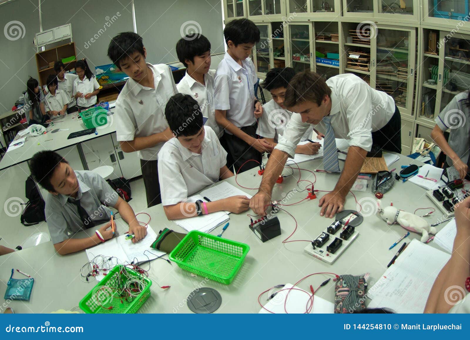 Group of Asian Elementary Students are Learning about Electricity in ...