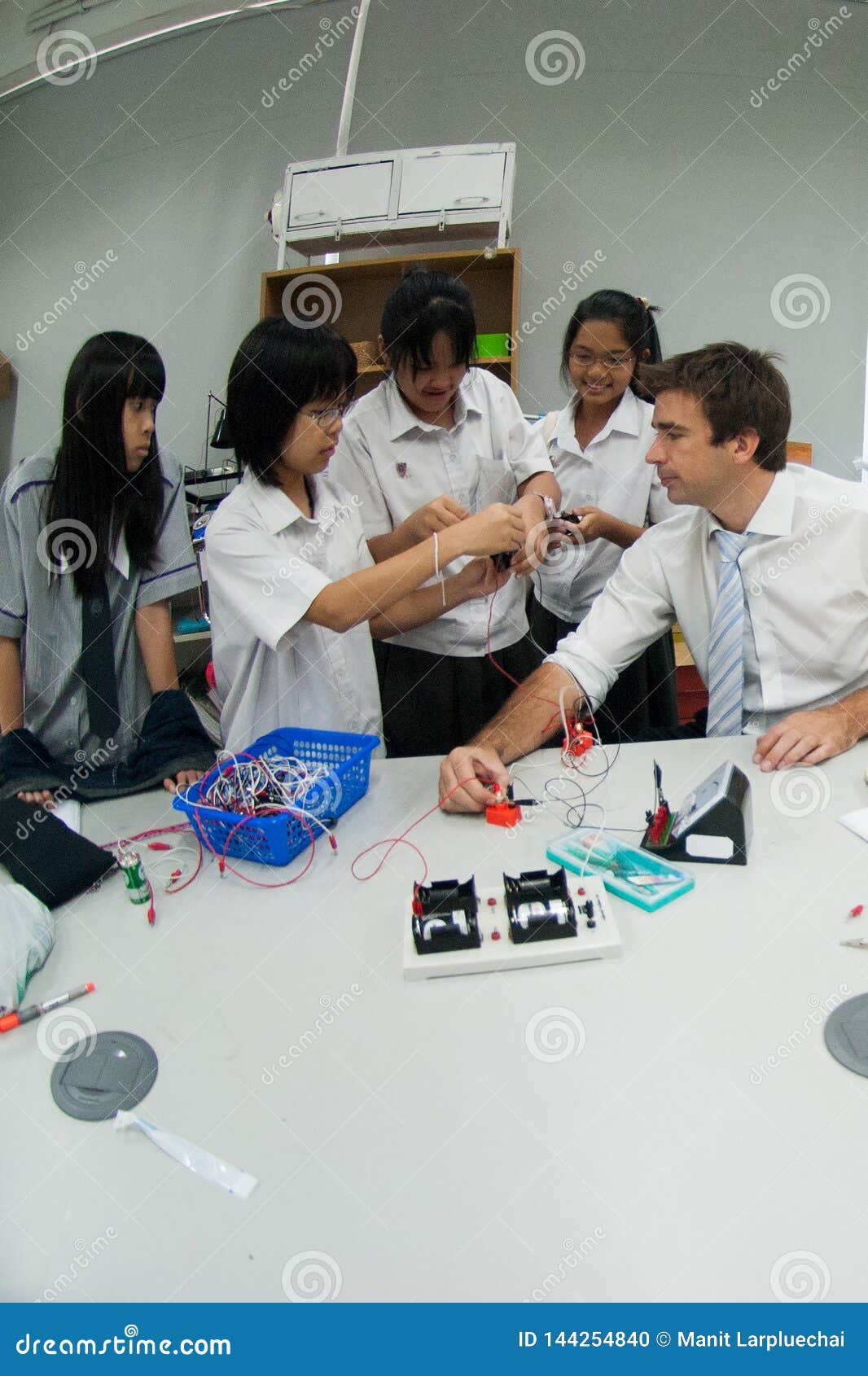 Group of Asian Elementary Students are Learning about Electricity in ...
