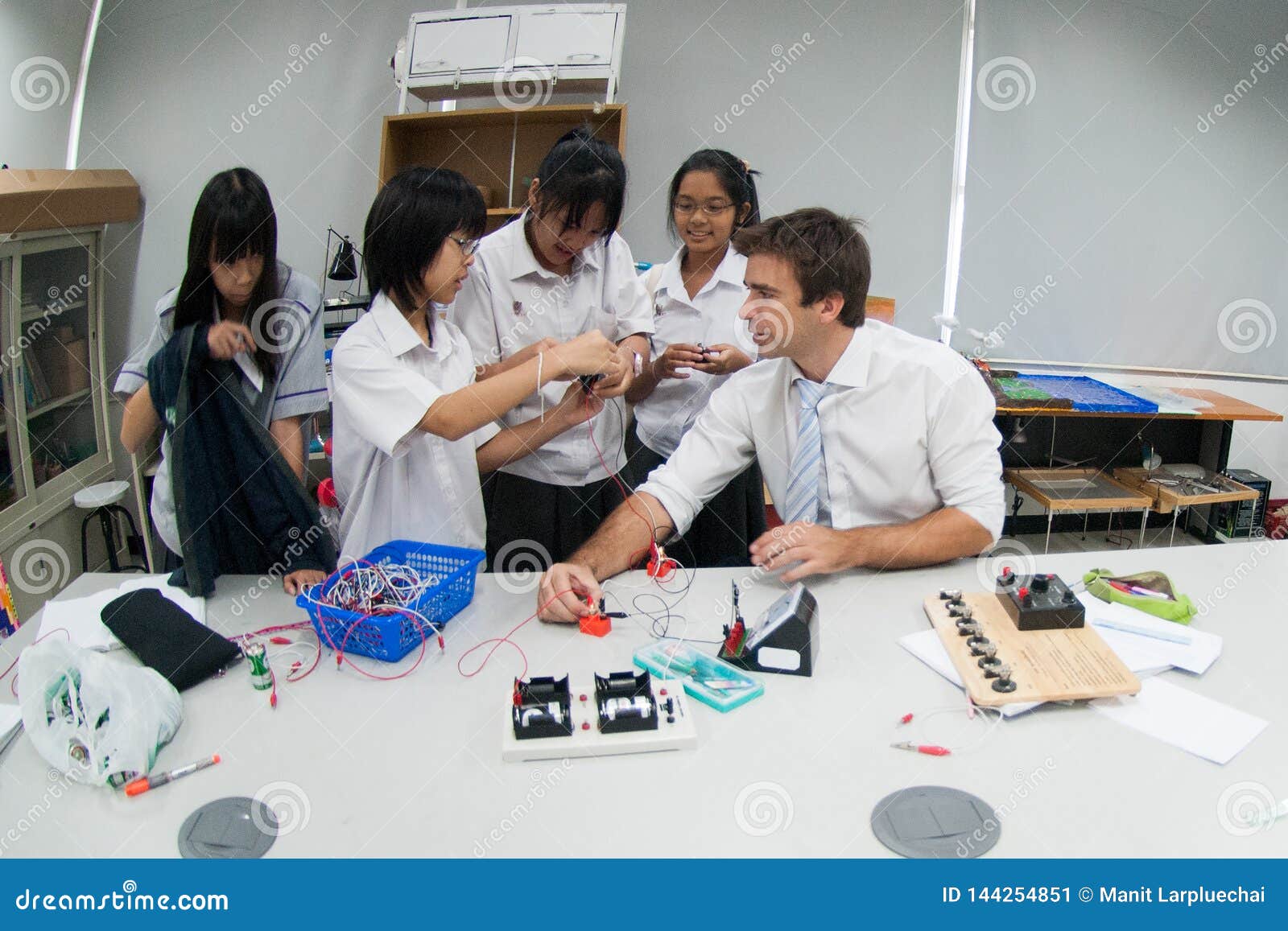 Group of Asian Elementary Students are Learning about Electricity in ...