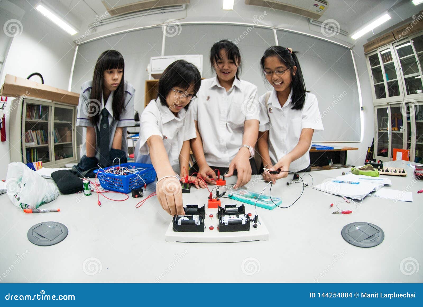 Group of Asian Elementary Students are Learning about Electricity in ...