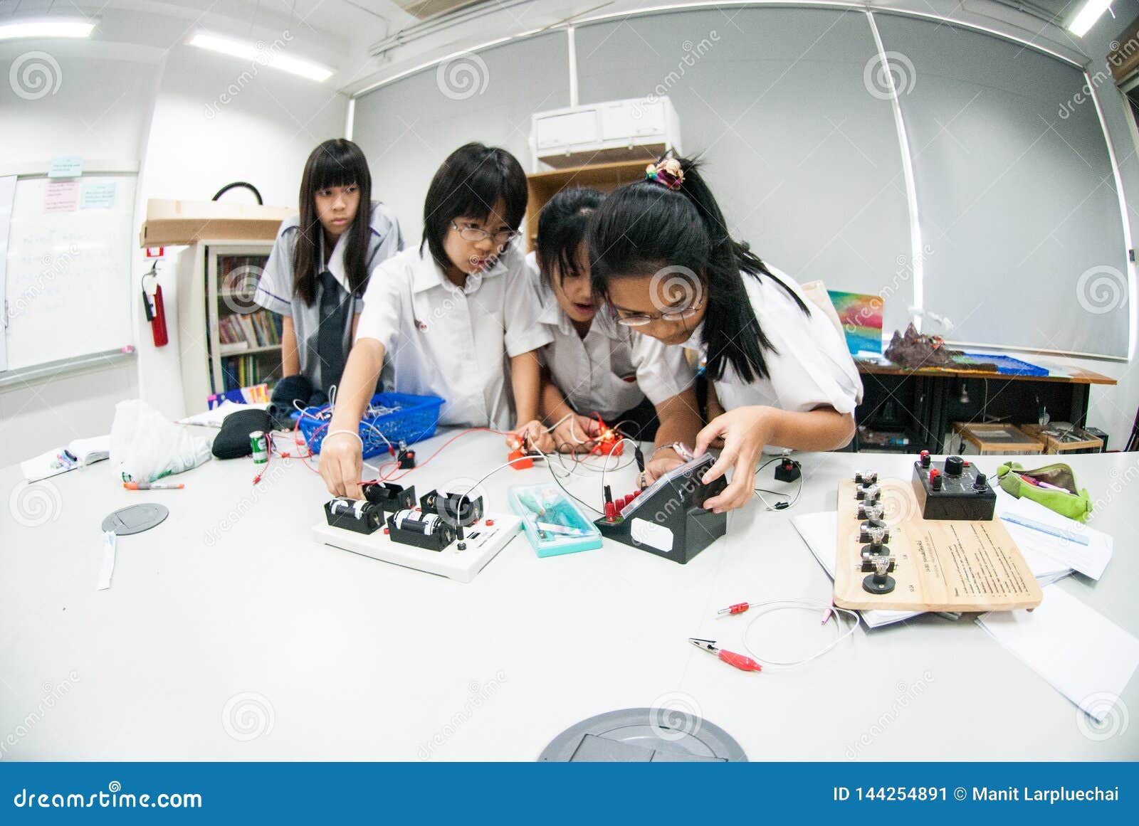 Group of Asian Elementary Students are Learning about Electricity in ...