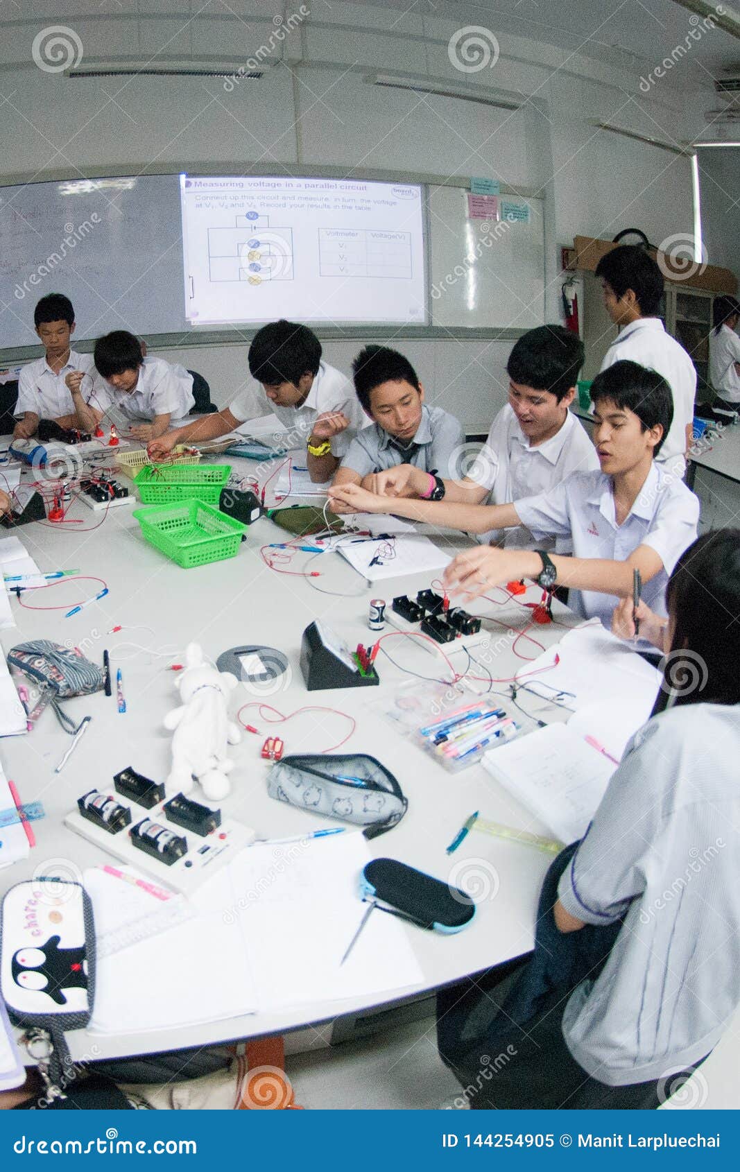 Group of Asian Elementary Students are Learning about Electricity in ...