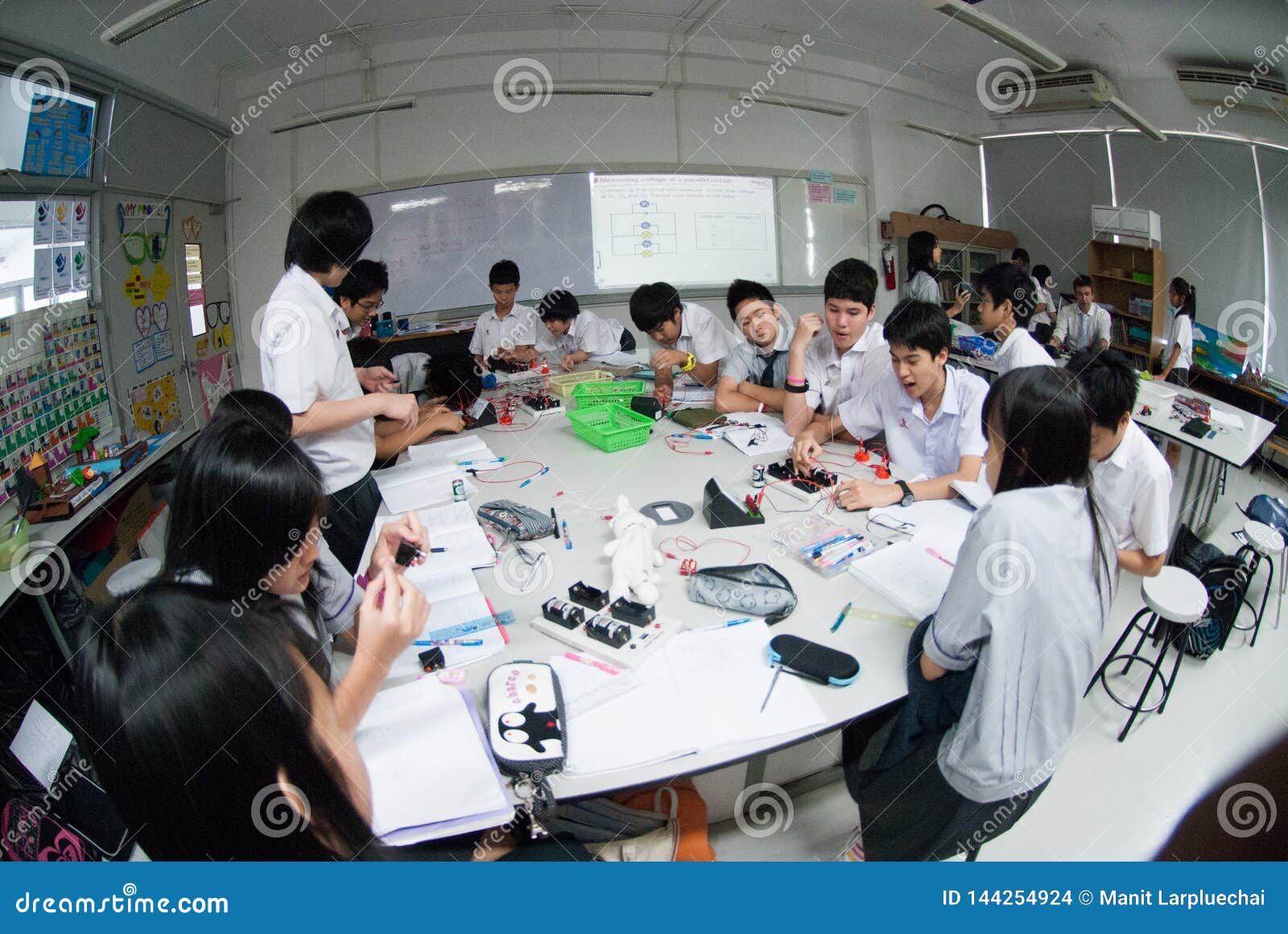 Group of Asian Elementary Students are Learning about Electricity in ...