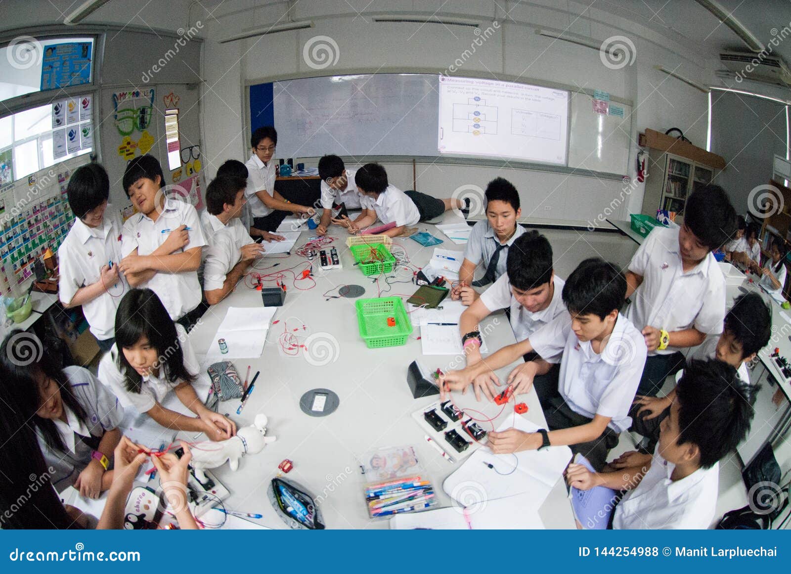 Group of Asian Elementary Students are Learning about Electricity in ...