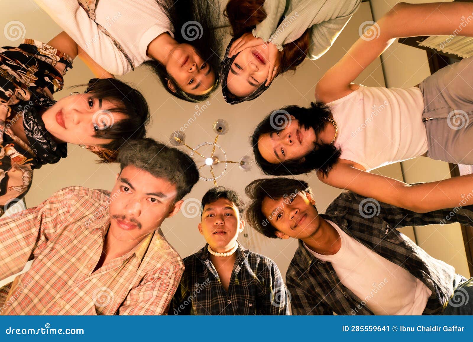 A Group of Asian People are Looking Down Simultaneously with Serious ...