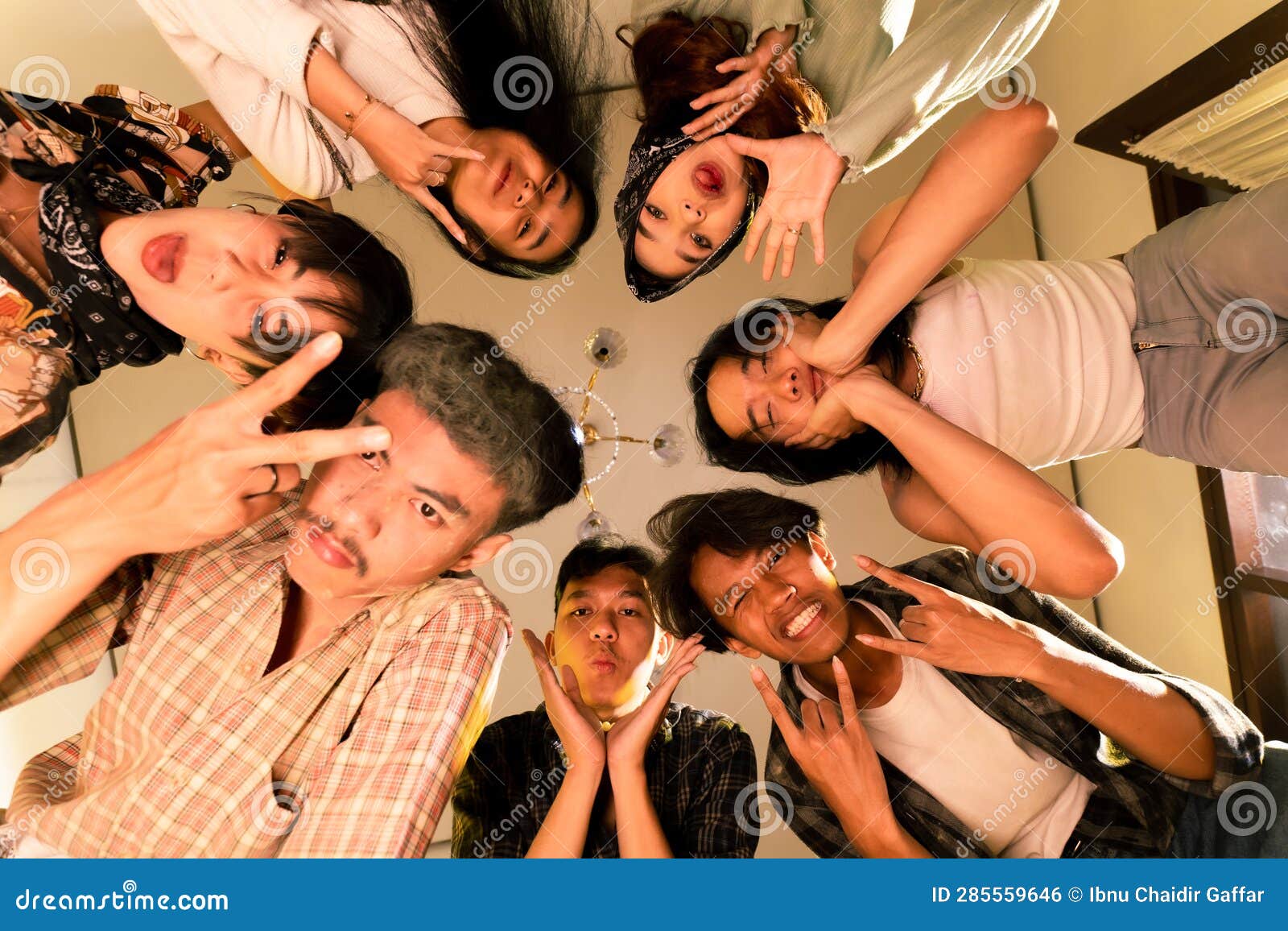 A Group of Asian People are Looking Down Simultaneously with Serious ...