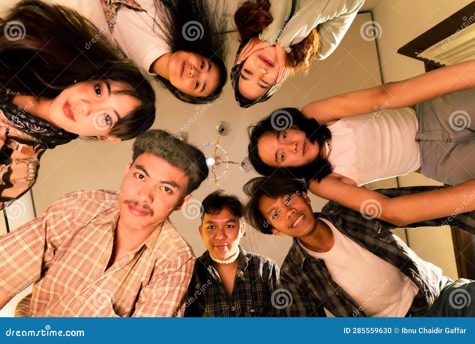 A Group of Asian People are Looking Down Simultaneously with Serious ...