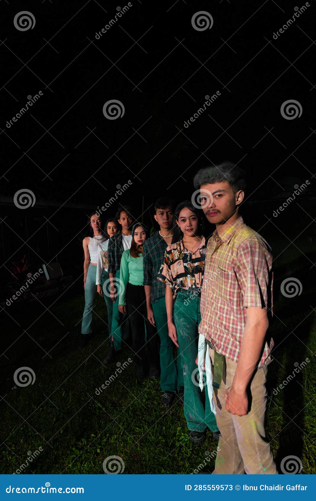 A Group of Asian People Standing and Lining Up Looking at the Camera ...