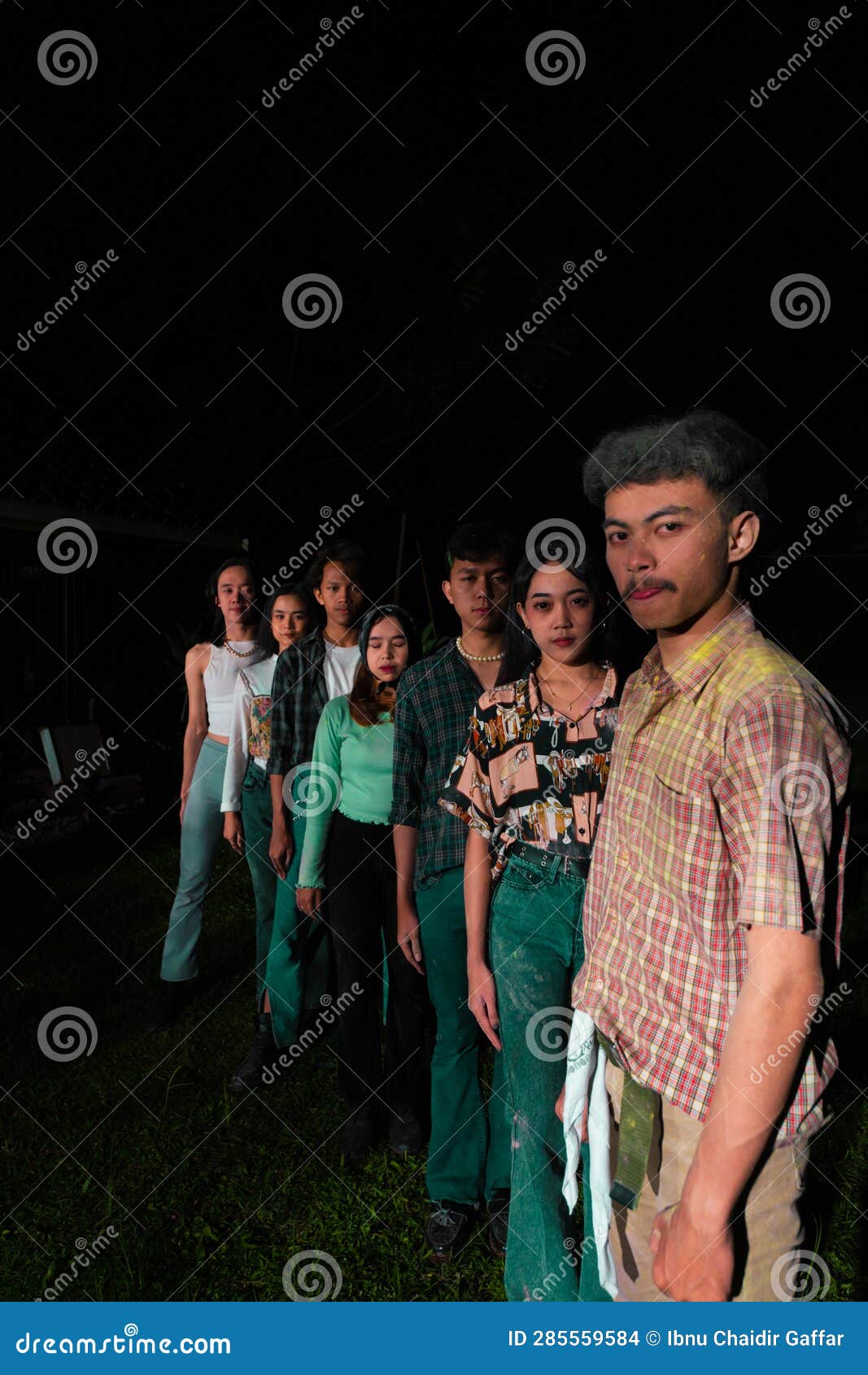 A Group of Asian People Standing and Lining Up Looking at the Camera ...