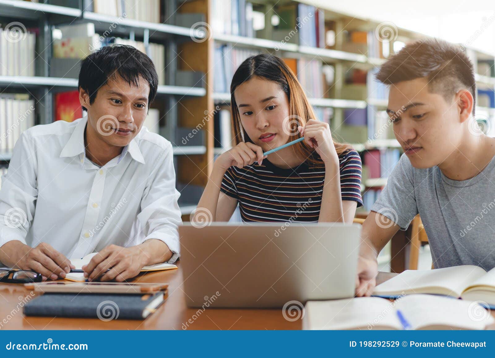 Group of Asian Students Researching for Project in Library of ...