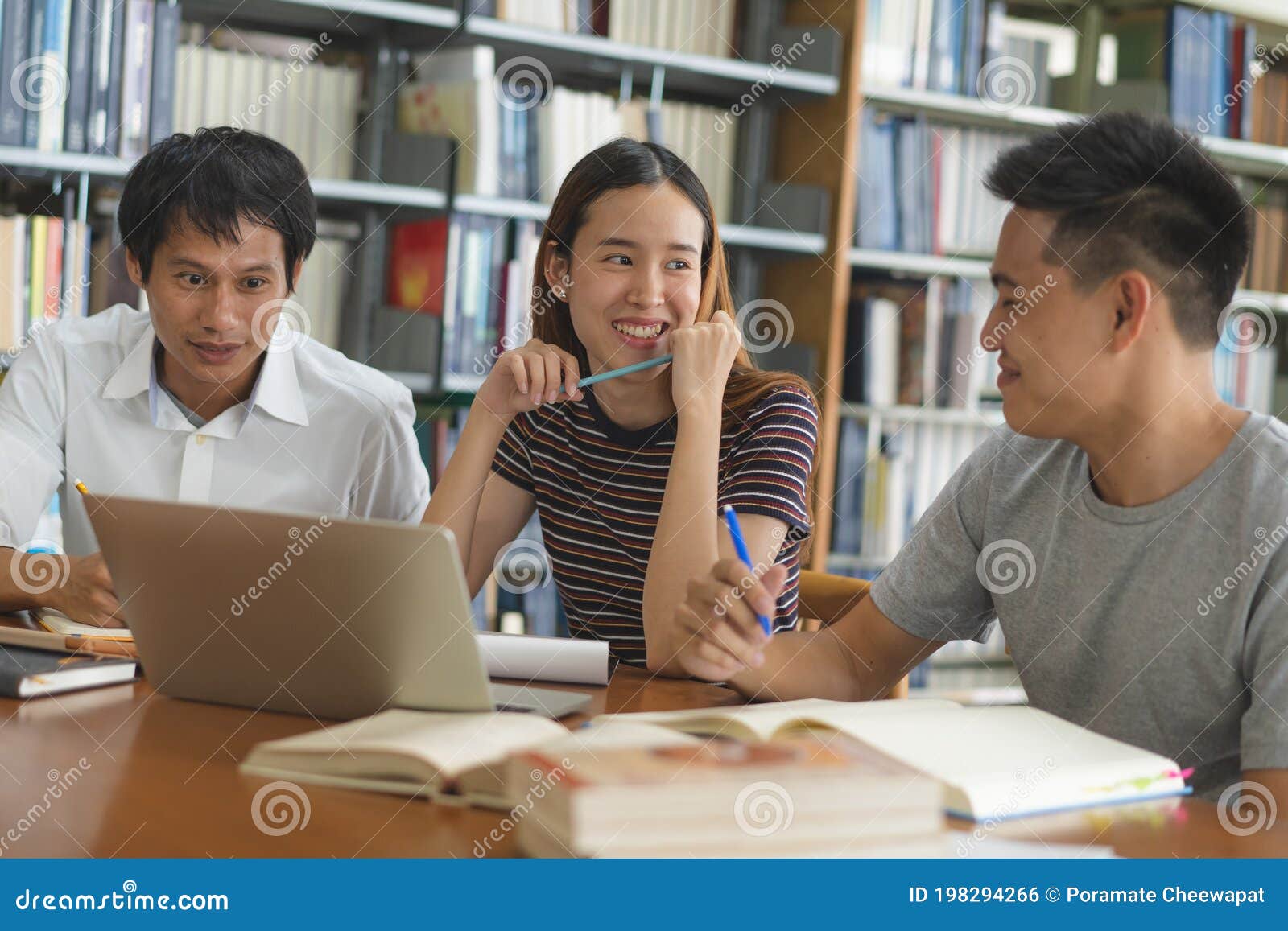 Group of Asian Students Researching for Project in Library of ...