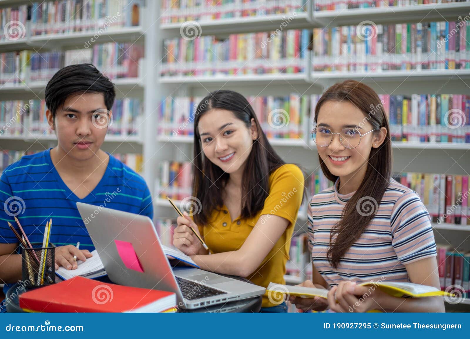 Group Asian Students Smile and Reading Book and Using Notebook for ...