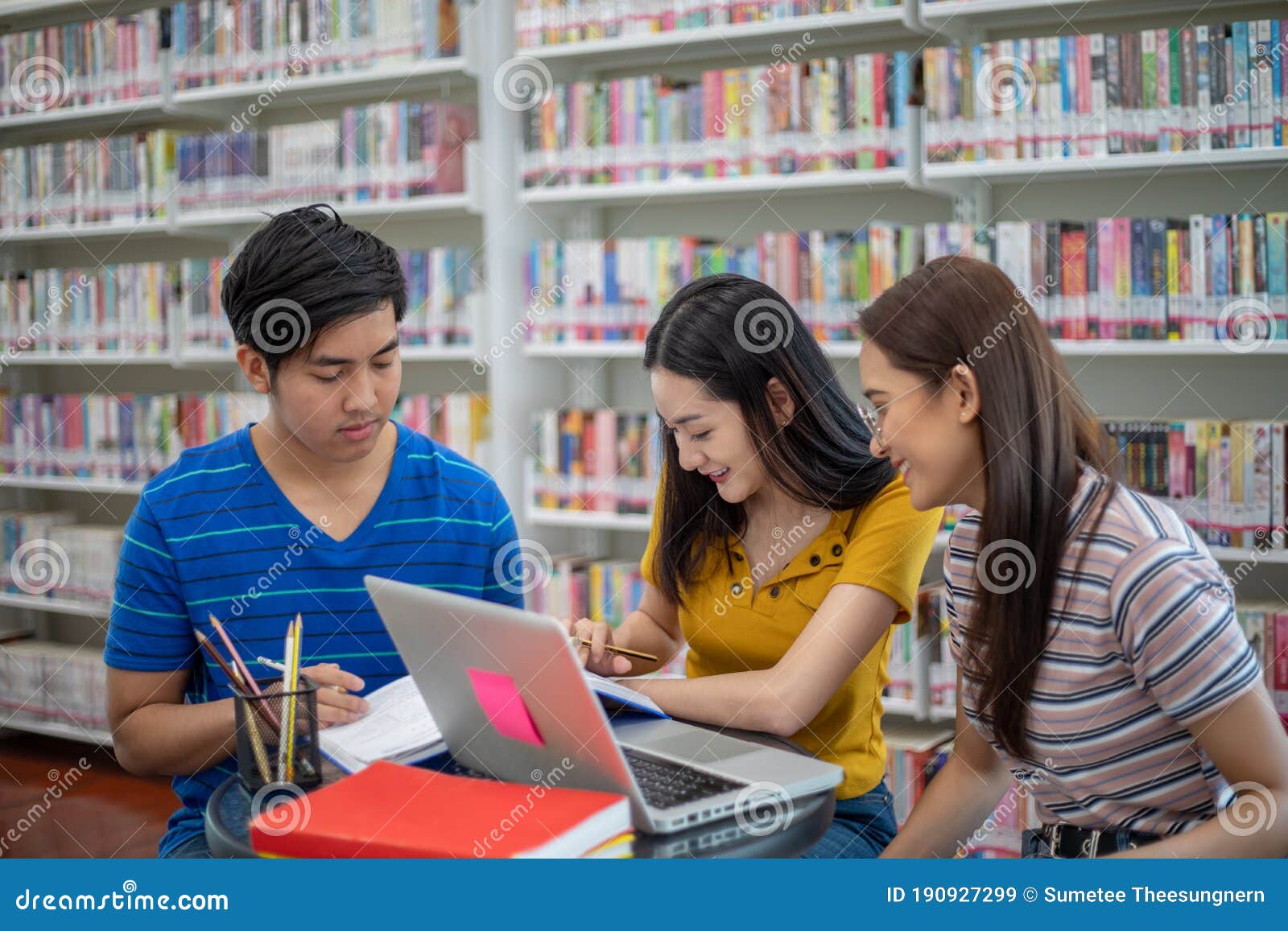 Group Asian Students Smile and Reading Book and Using Notebook for ...