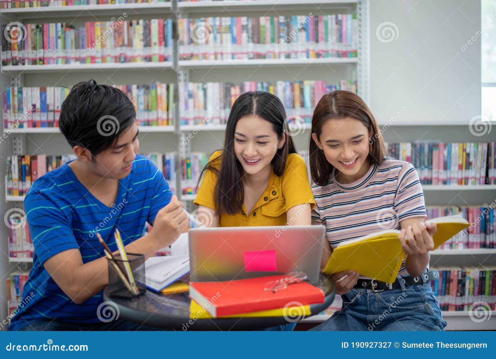 Group Asian Students Smile and Reading Book and Using Notebook for ...