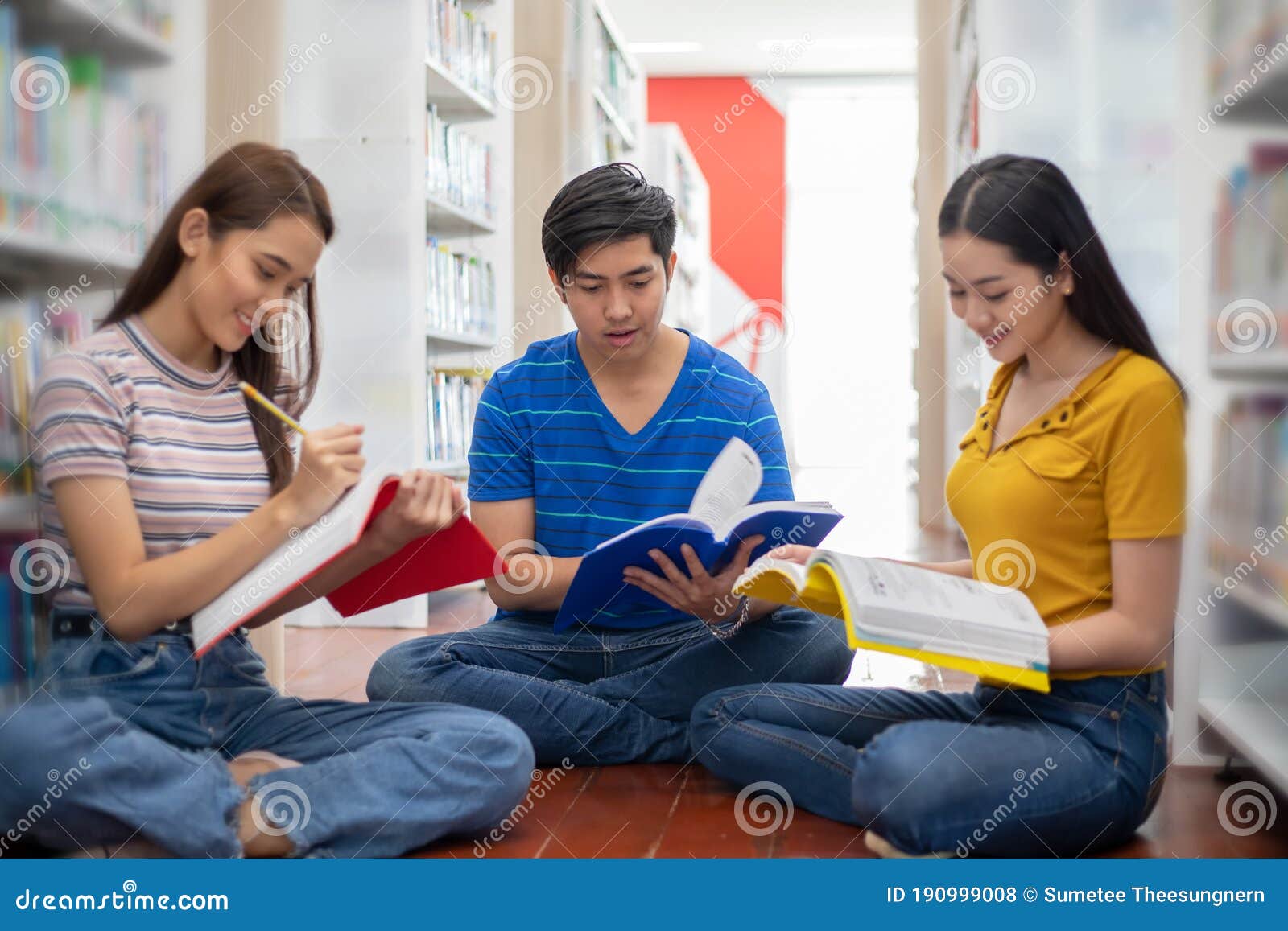 Group Asian Students Smile and Reading Book and Using Notebook for ...