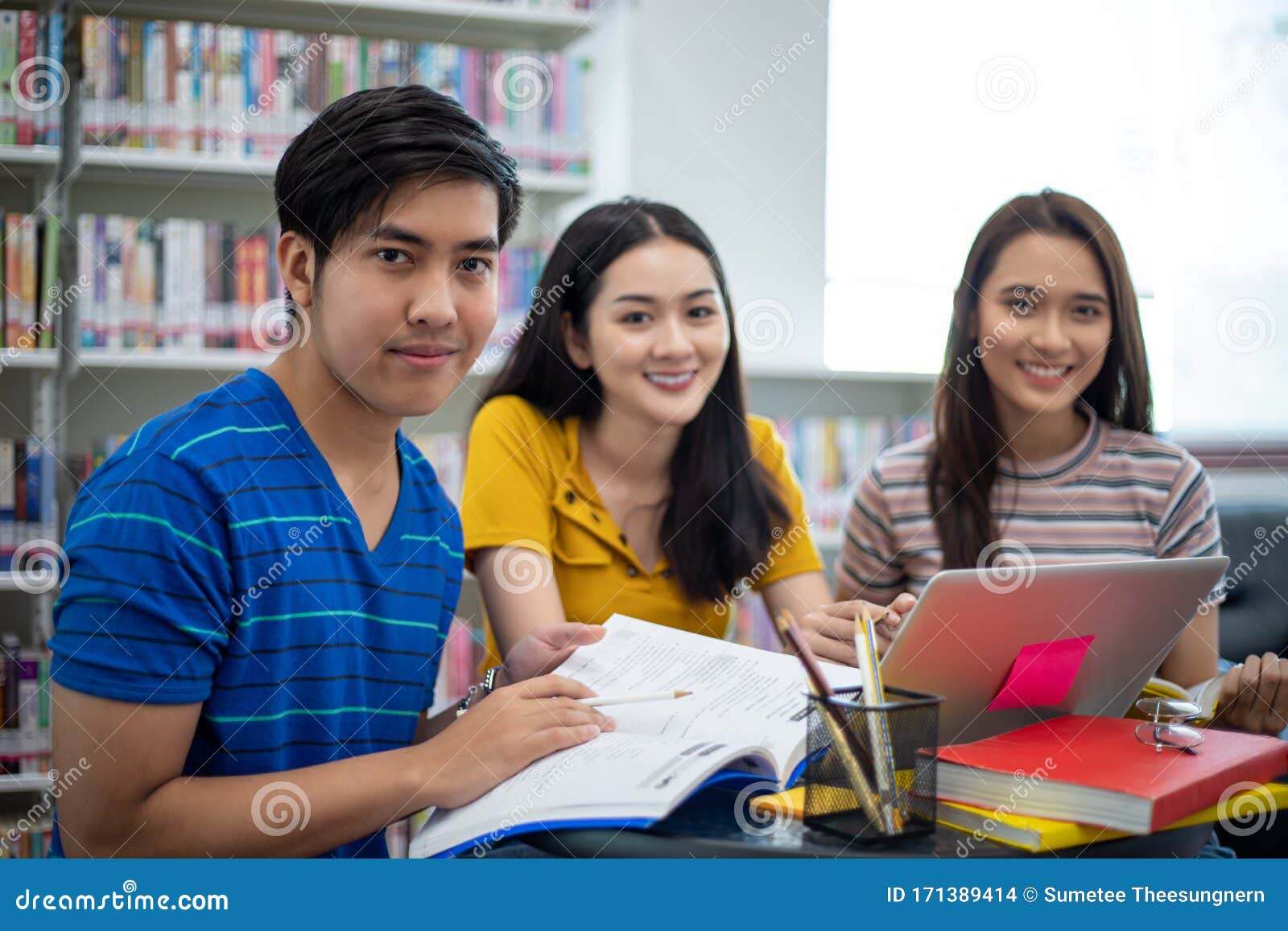 Group Asian Students Smile and Reading Book and Using Notebook for ...