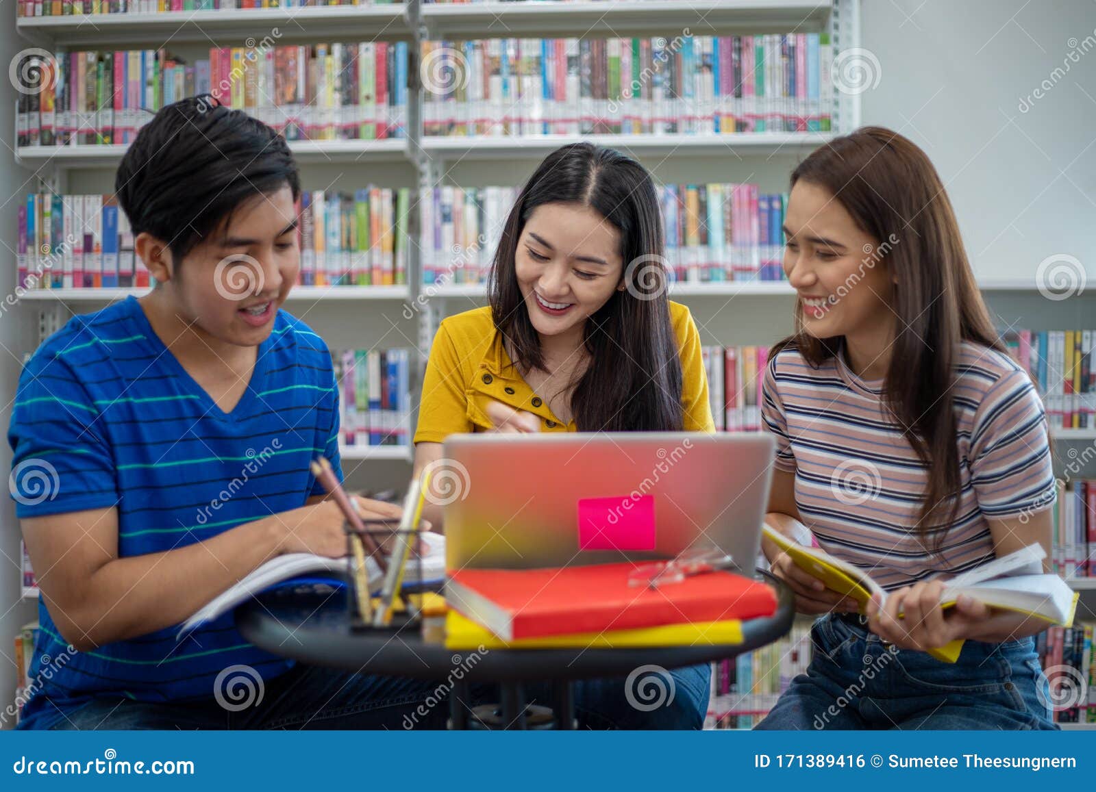 Group Asian Students Smile and Reading Book and Using Notebook for ...