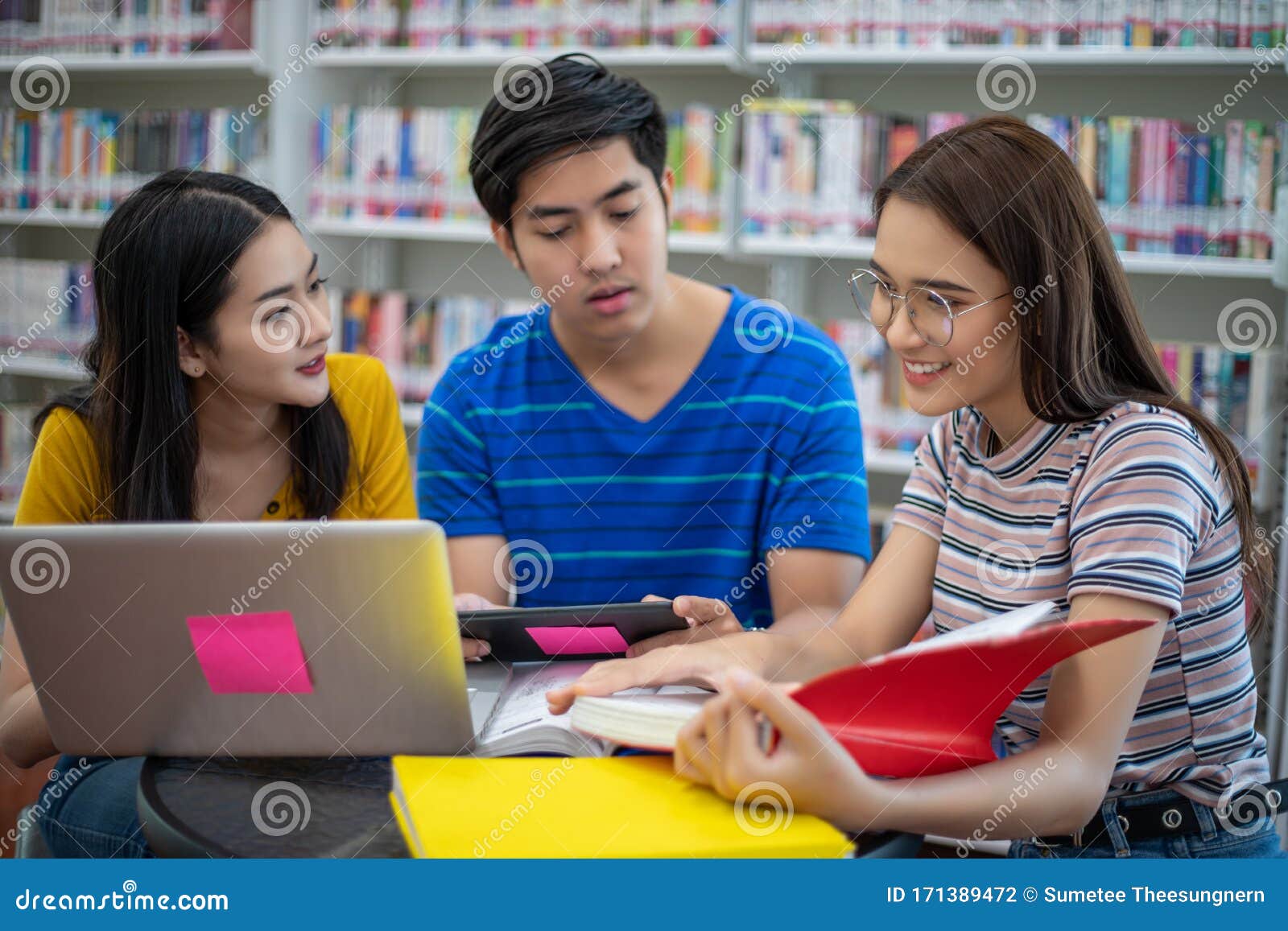 Group Asian Students Smile and Reading Book and Using Notebook for ...