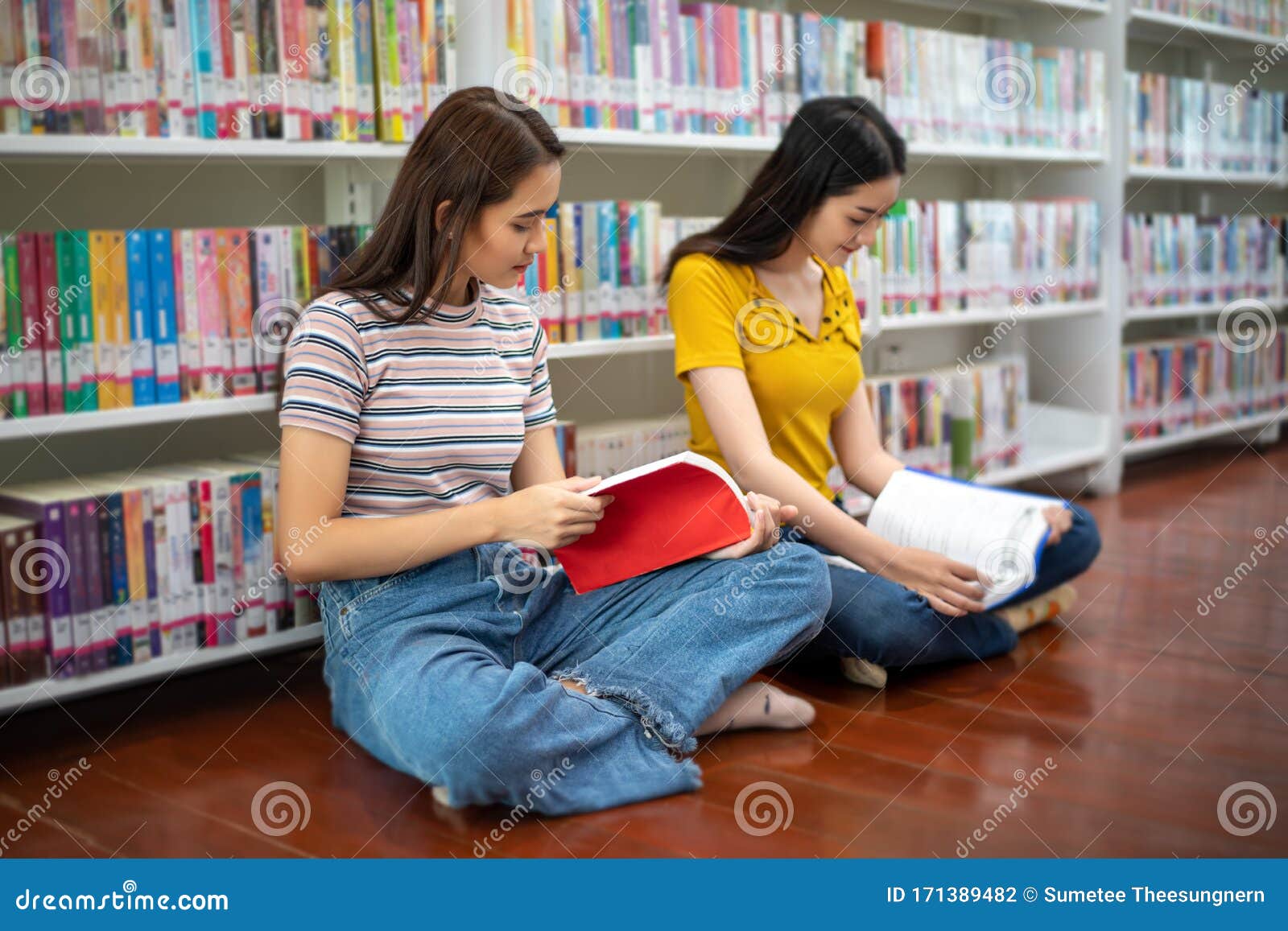 Group Asian Students Smile and Reading Book and Using Notebook for ...