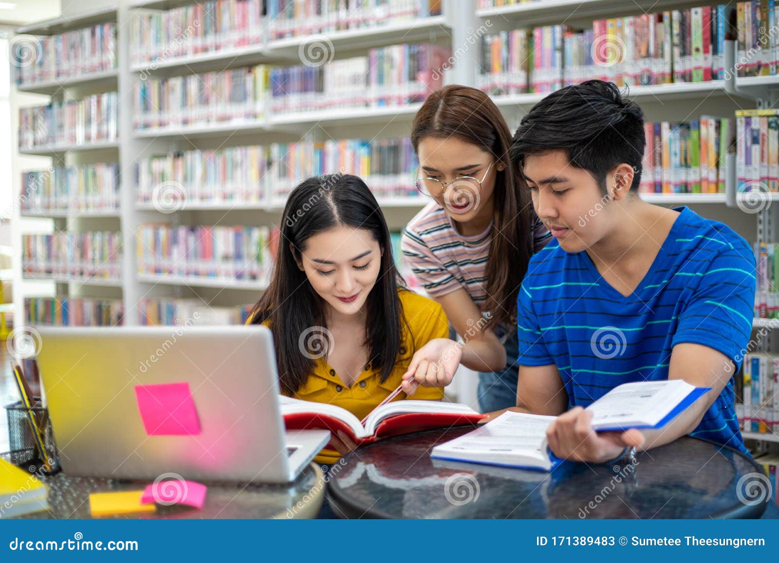 Group Asian Students Smile and Reading Book and Using Notebook for ...