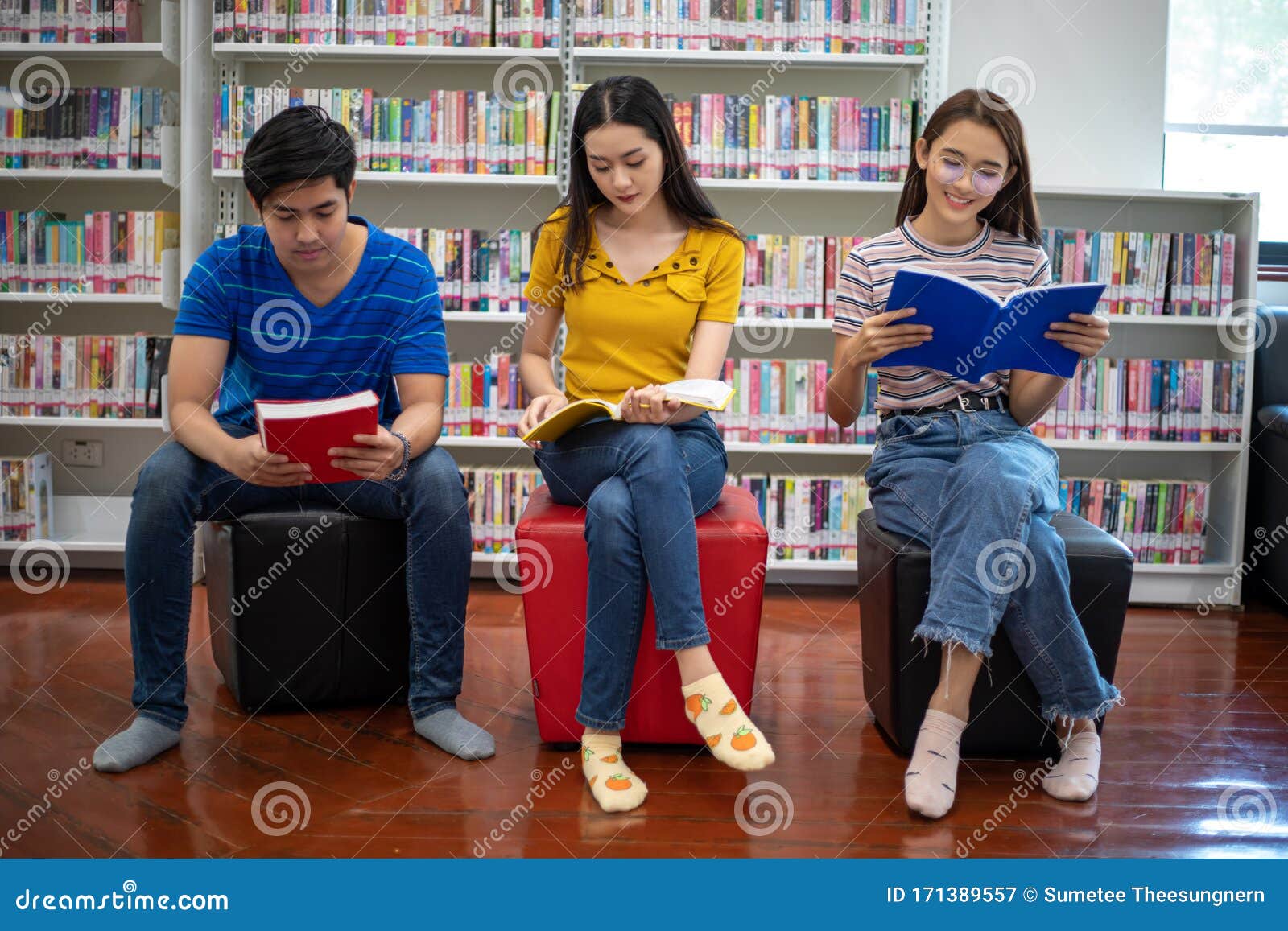 Group Asian Students Smile and Reading Book and Using Notebook for ...