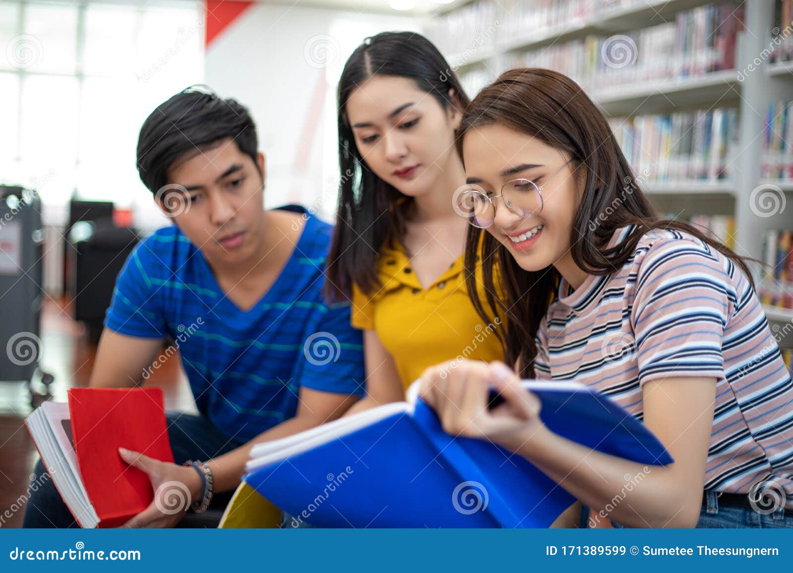 Group Asian Students Smile and Reading Book and Using Notebook for ...