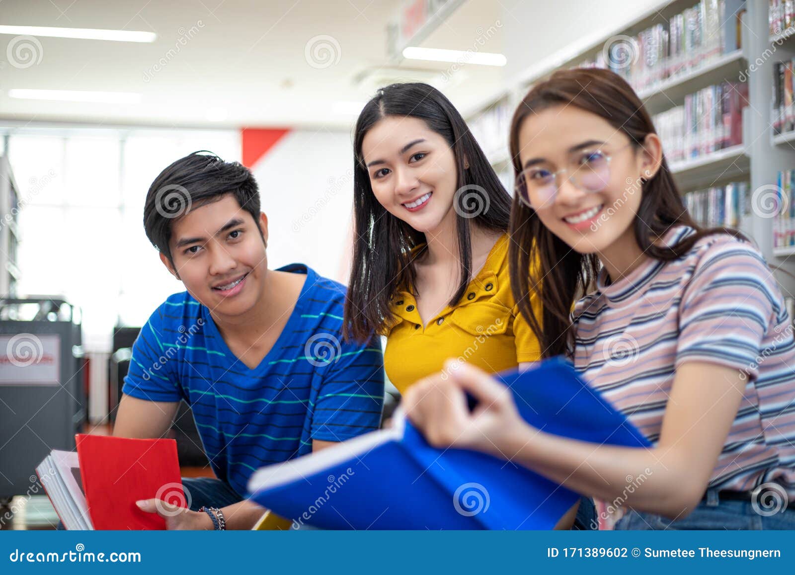 Group Asian Students Smile and Reading Book and Using Notebook for ...