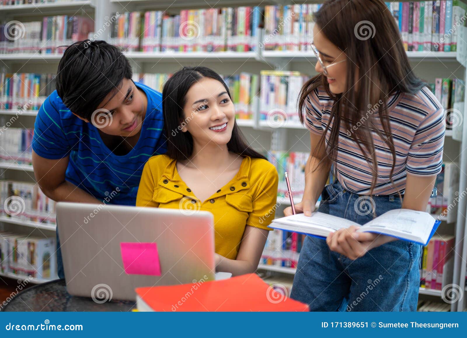 Group Asian Students Smile and Reading Book and Using Notebook for ...
