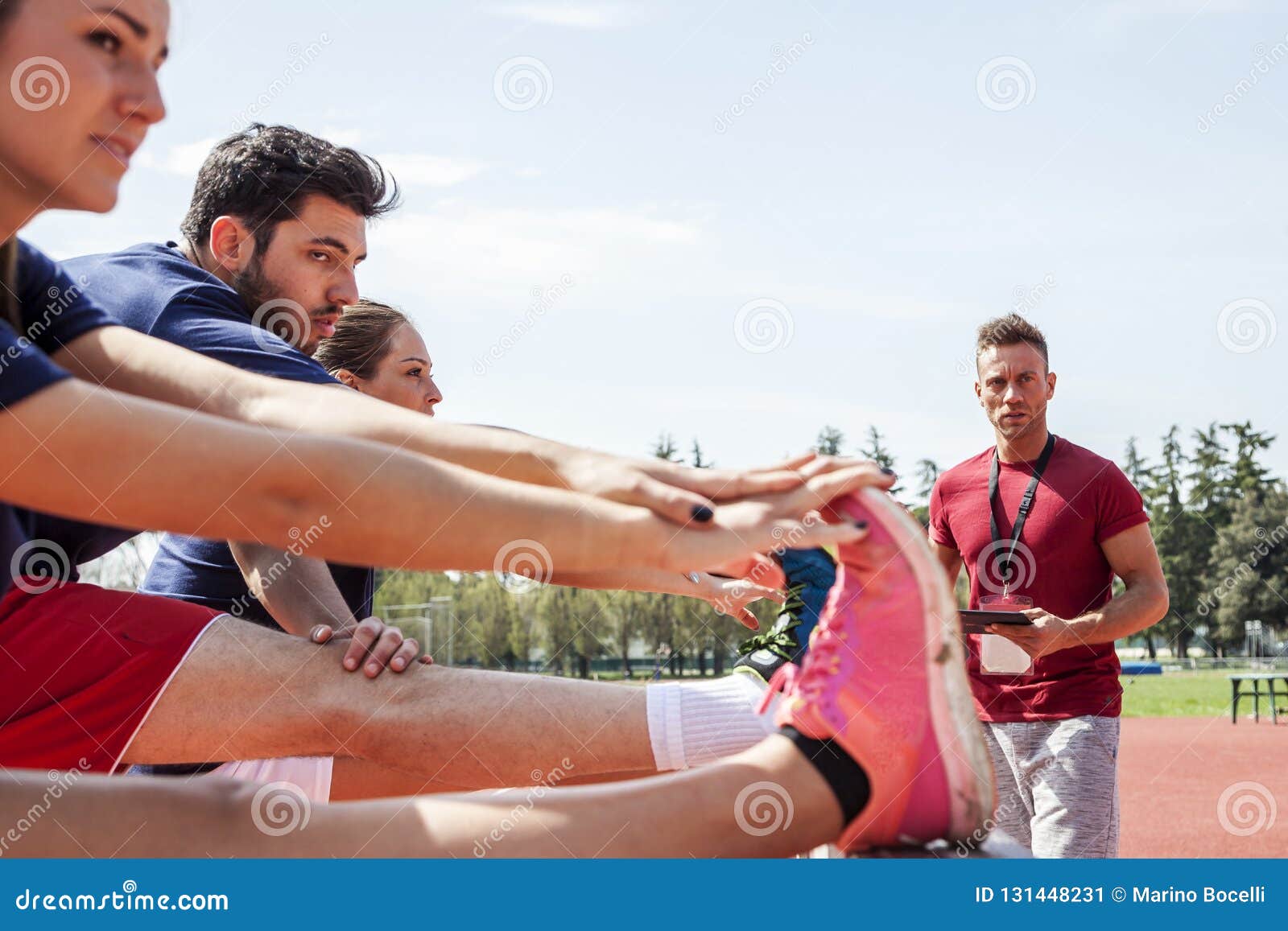 Group of Athletes Heats Up the Muscles before Course Stock Image ...
