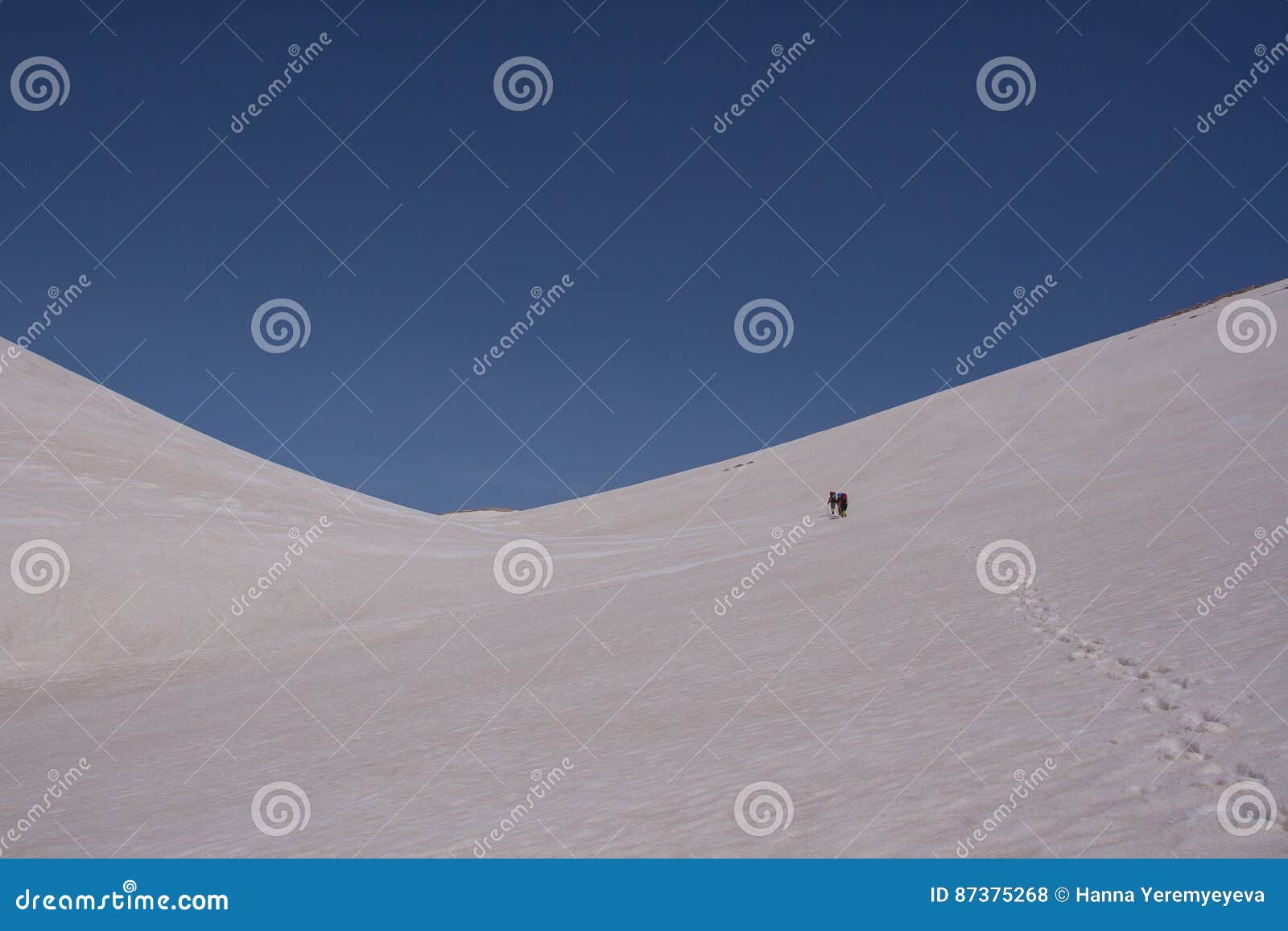 Group of Backpackers Going through the Ravine between Two Snow-covered ...