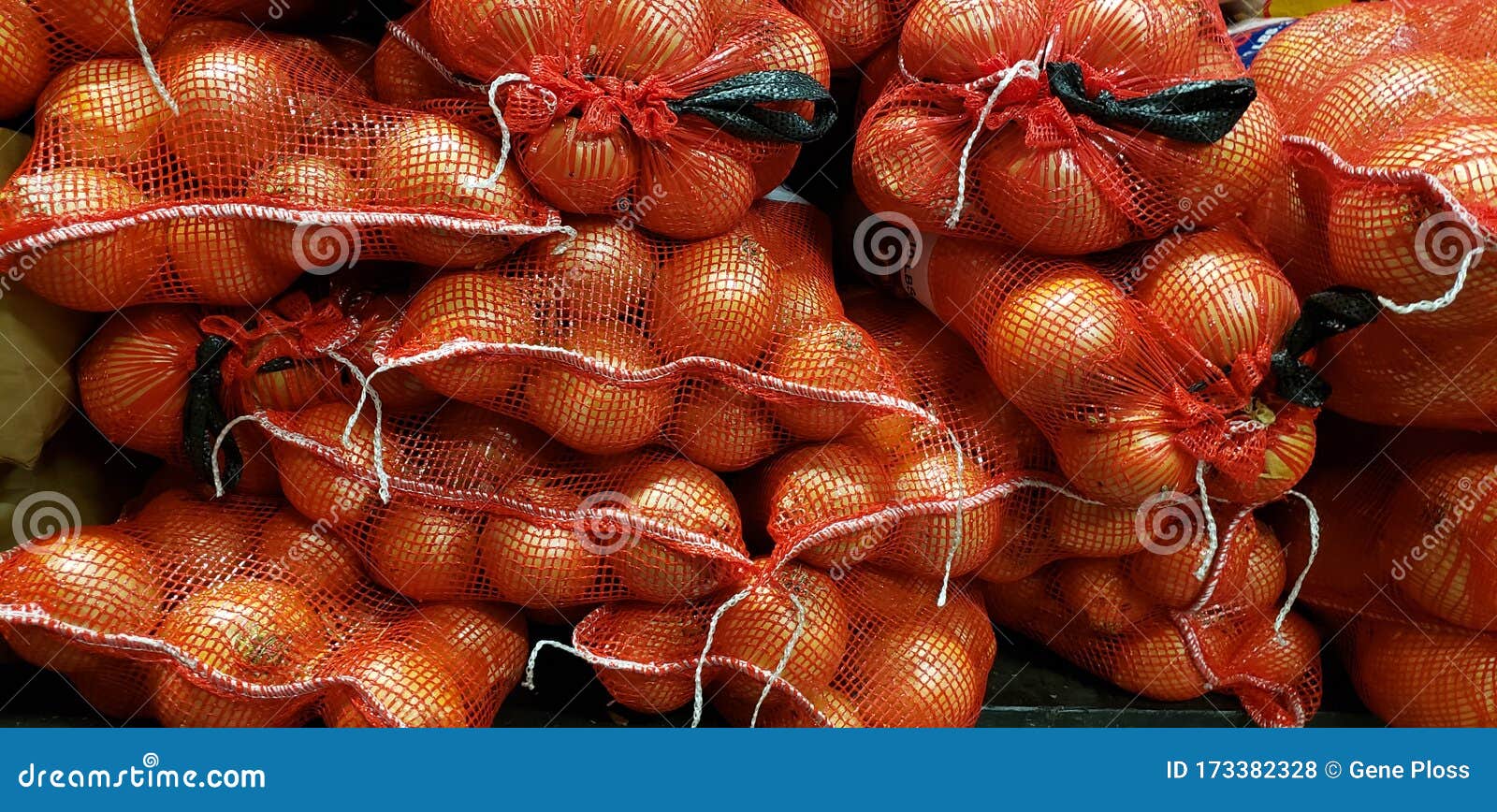 A Group of Bagged Yellow Onions Stacked Up in a Pile Stock Photo ...