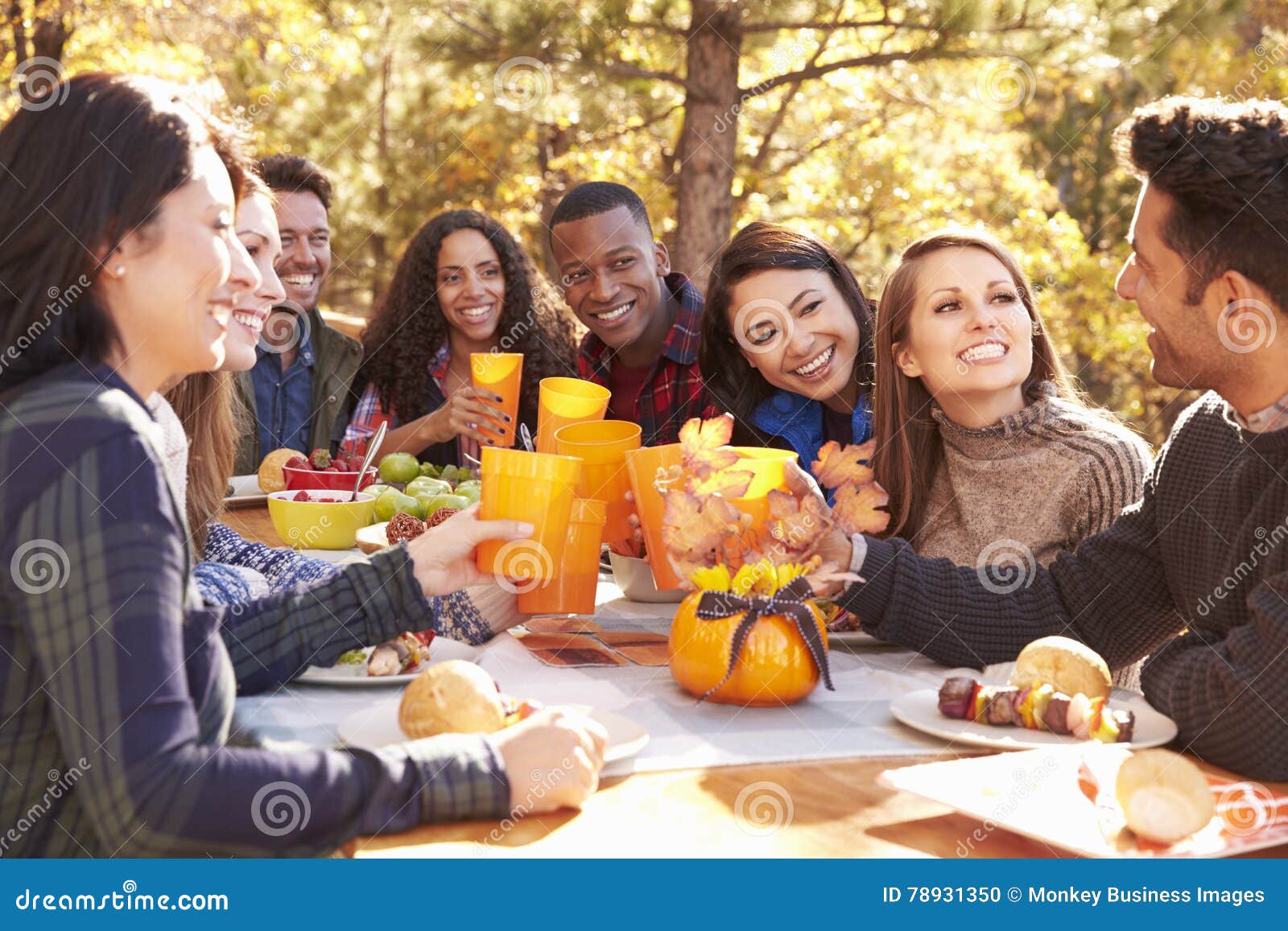 Group at a Barbecue Sitting at Table All Looking To One Friend Stock ...