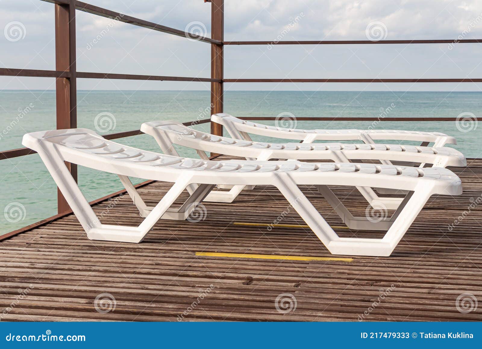 Group of Beautiful White Plastic Sunbeds is on the Beach by Sea Stock ...