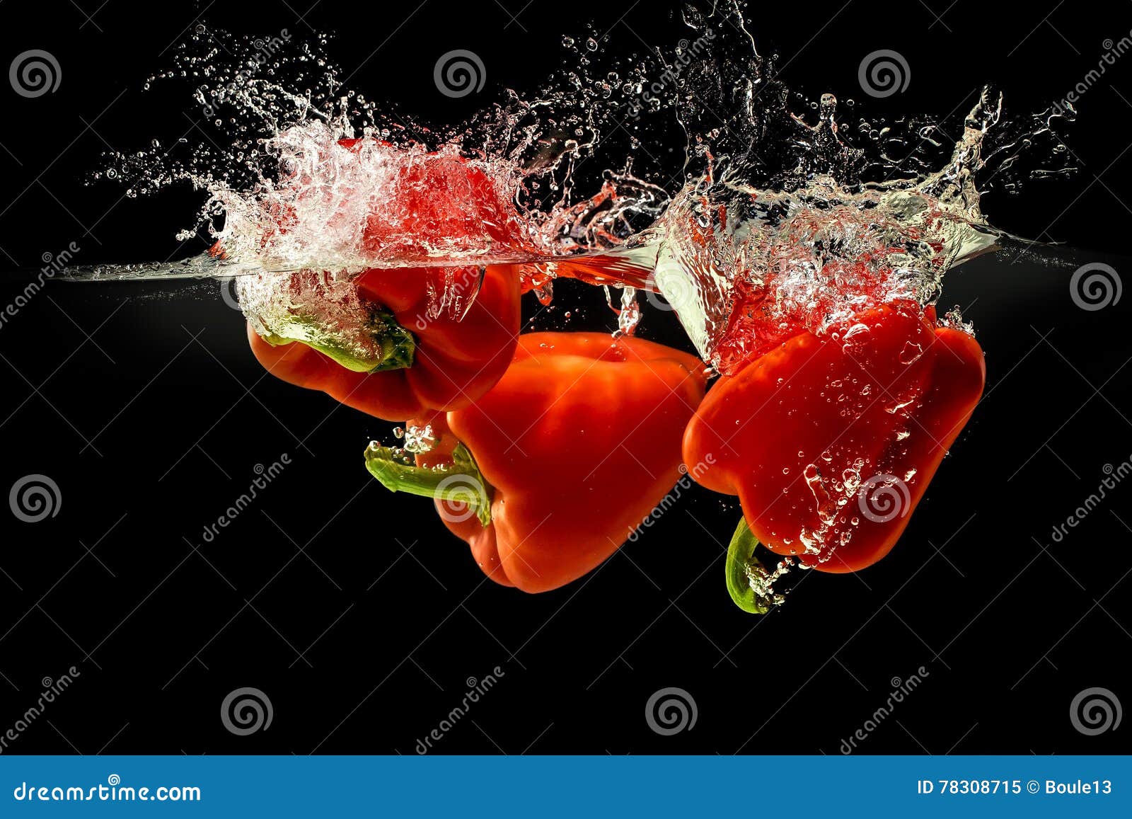 Group of Bell Pepper Falling in Water with Splash on Black Background ...