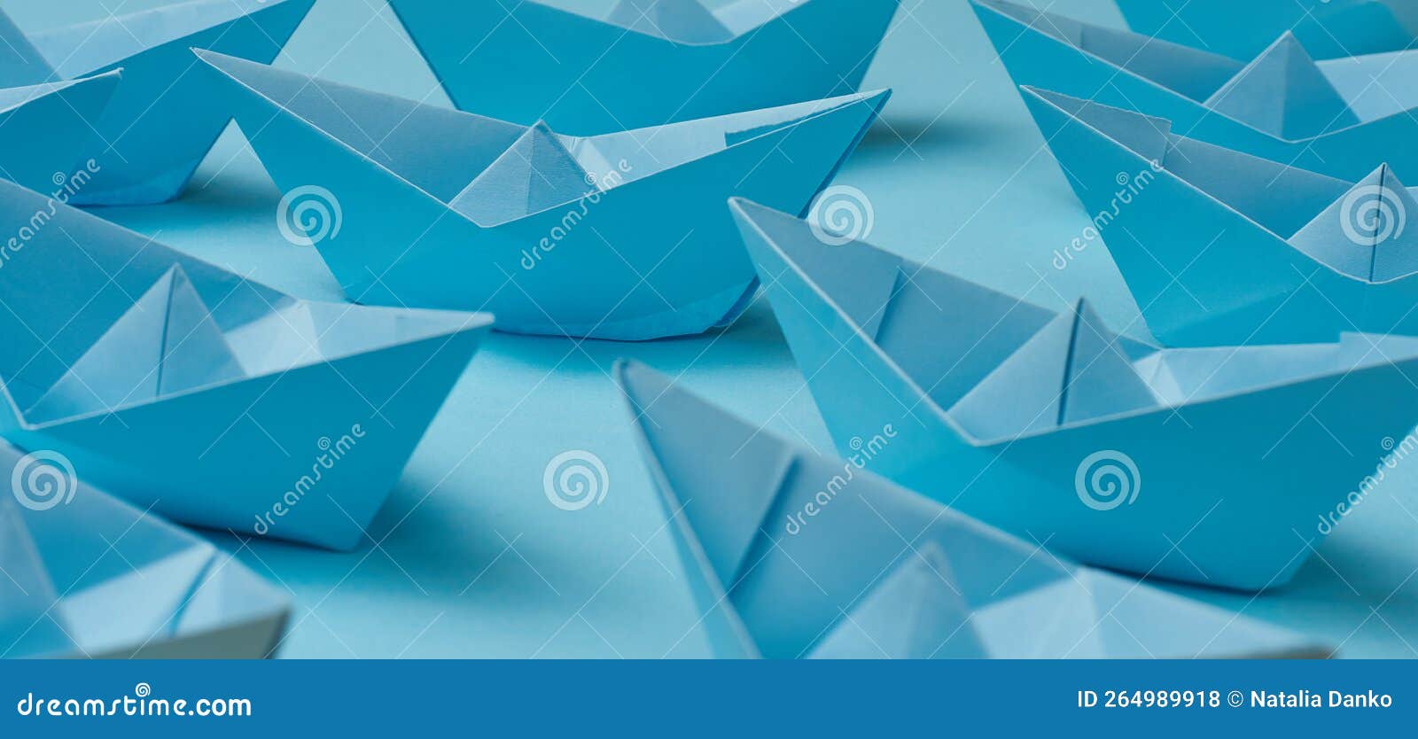 A Group of Blue Paper Boats on a Blue Background. the Concept of a ...