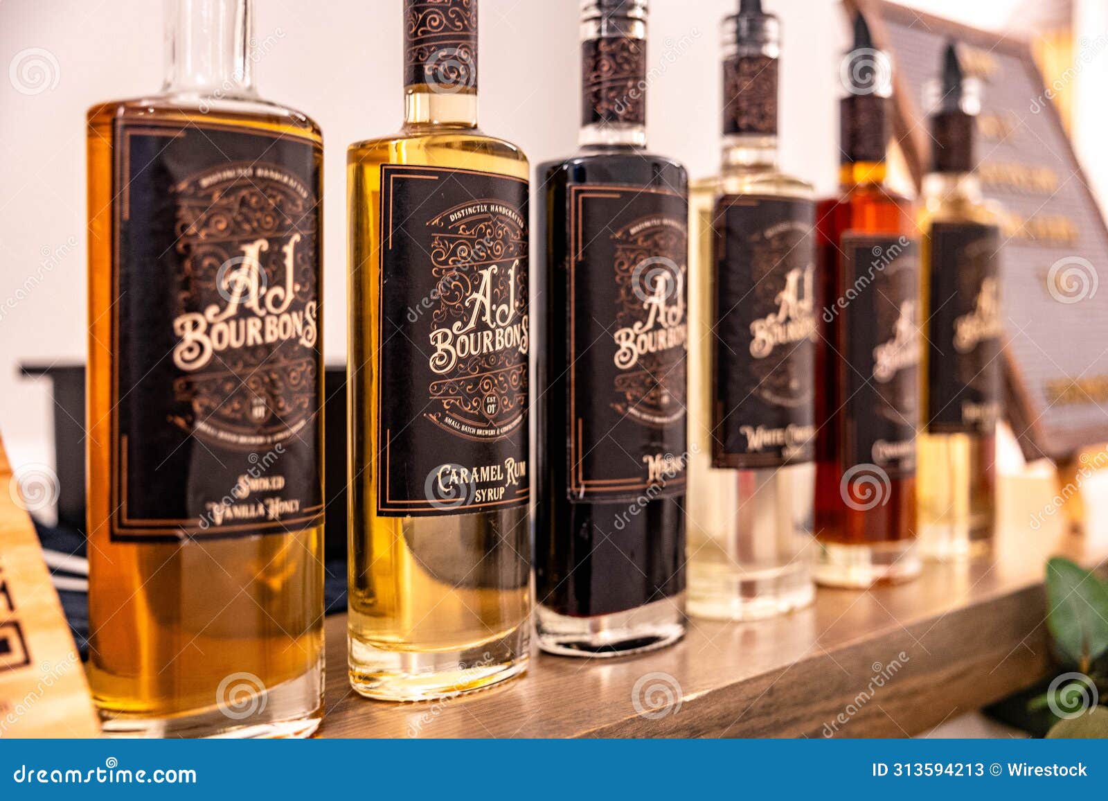 A Group of Bottles of Various Types of Alcohol on a Shelf Editorial ...